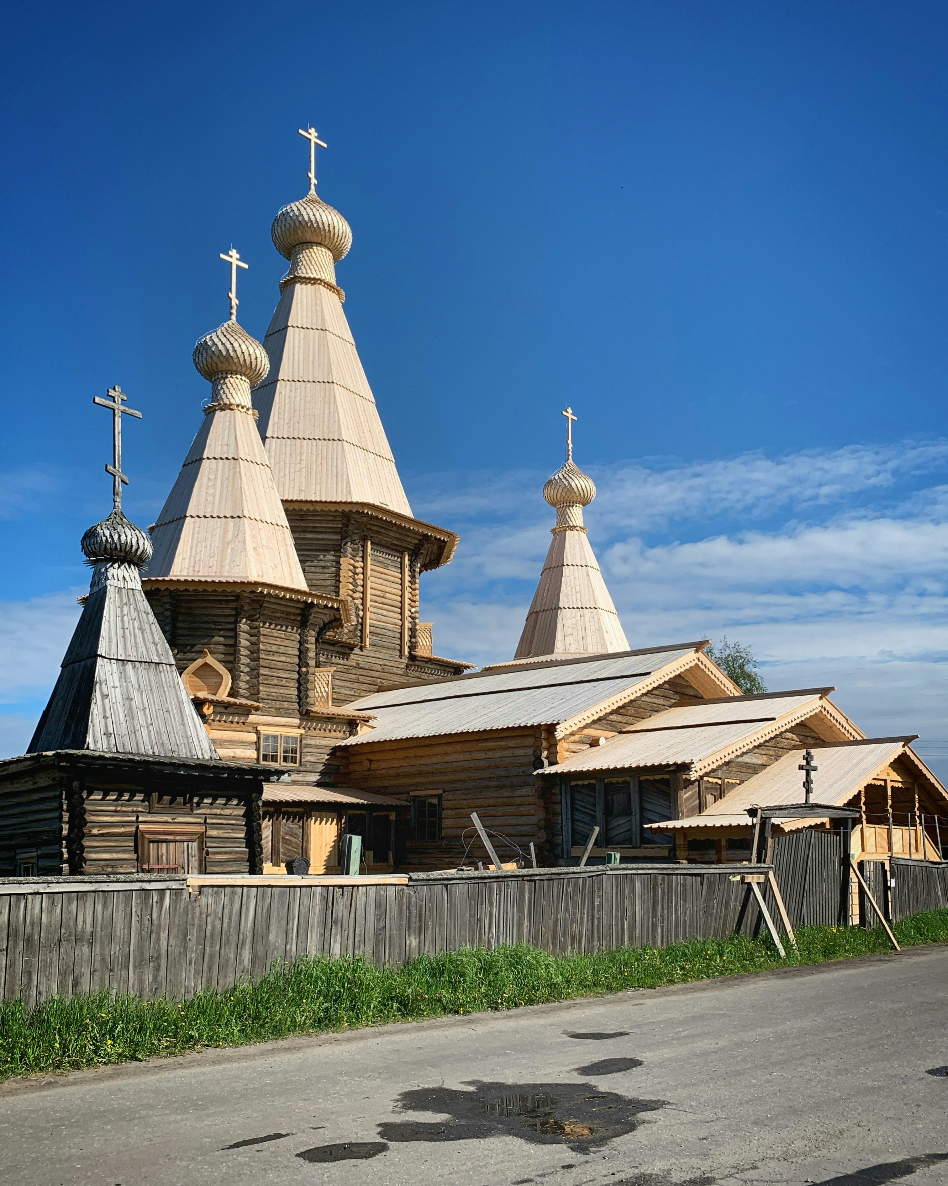 Onion-Domed Timber Church Framed by a Quiet Fence