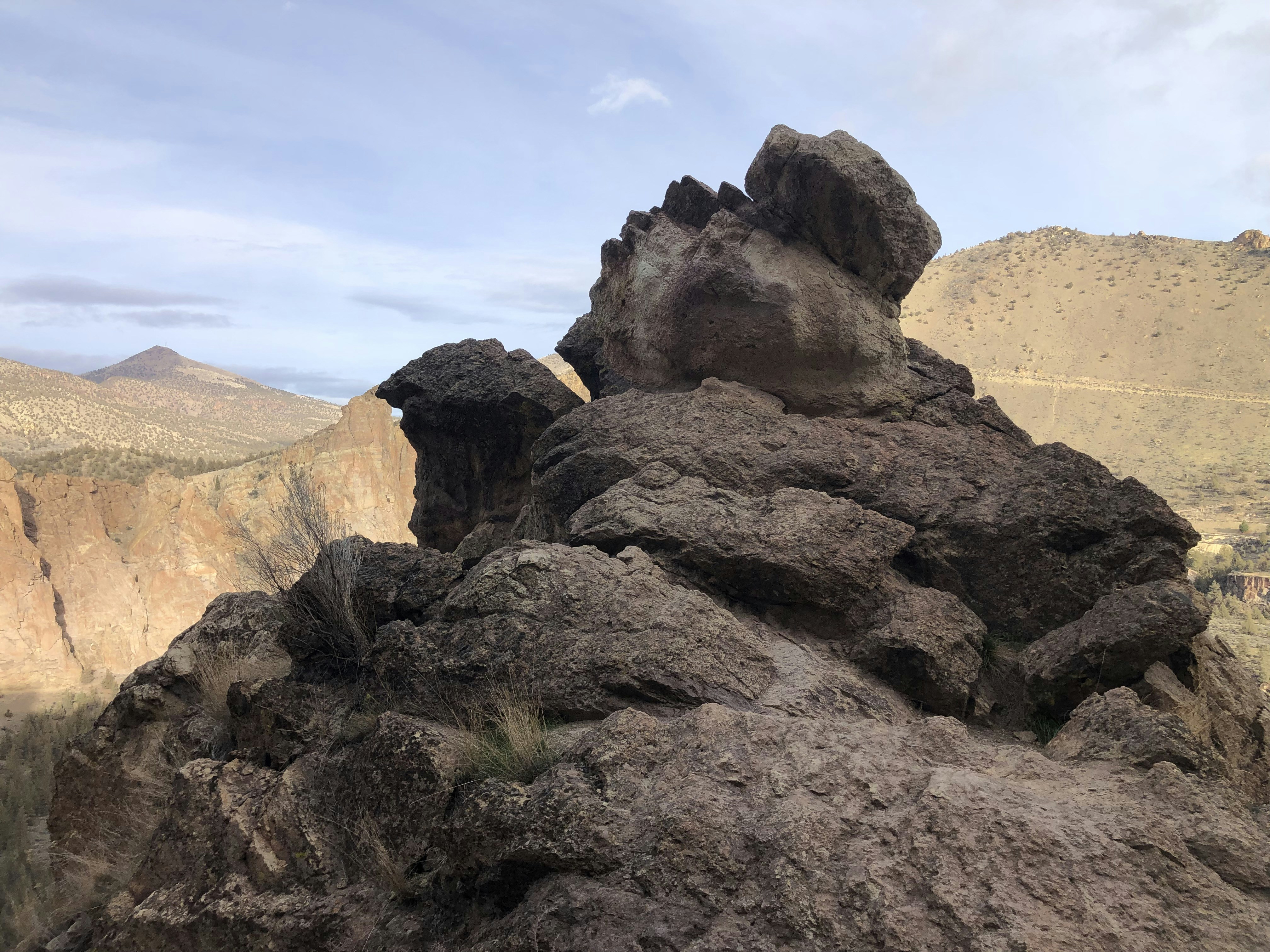 A rocky outcropping with mountains in the background photo – Free Rock ...