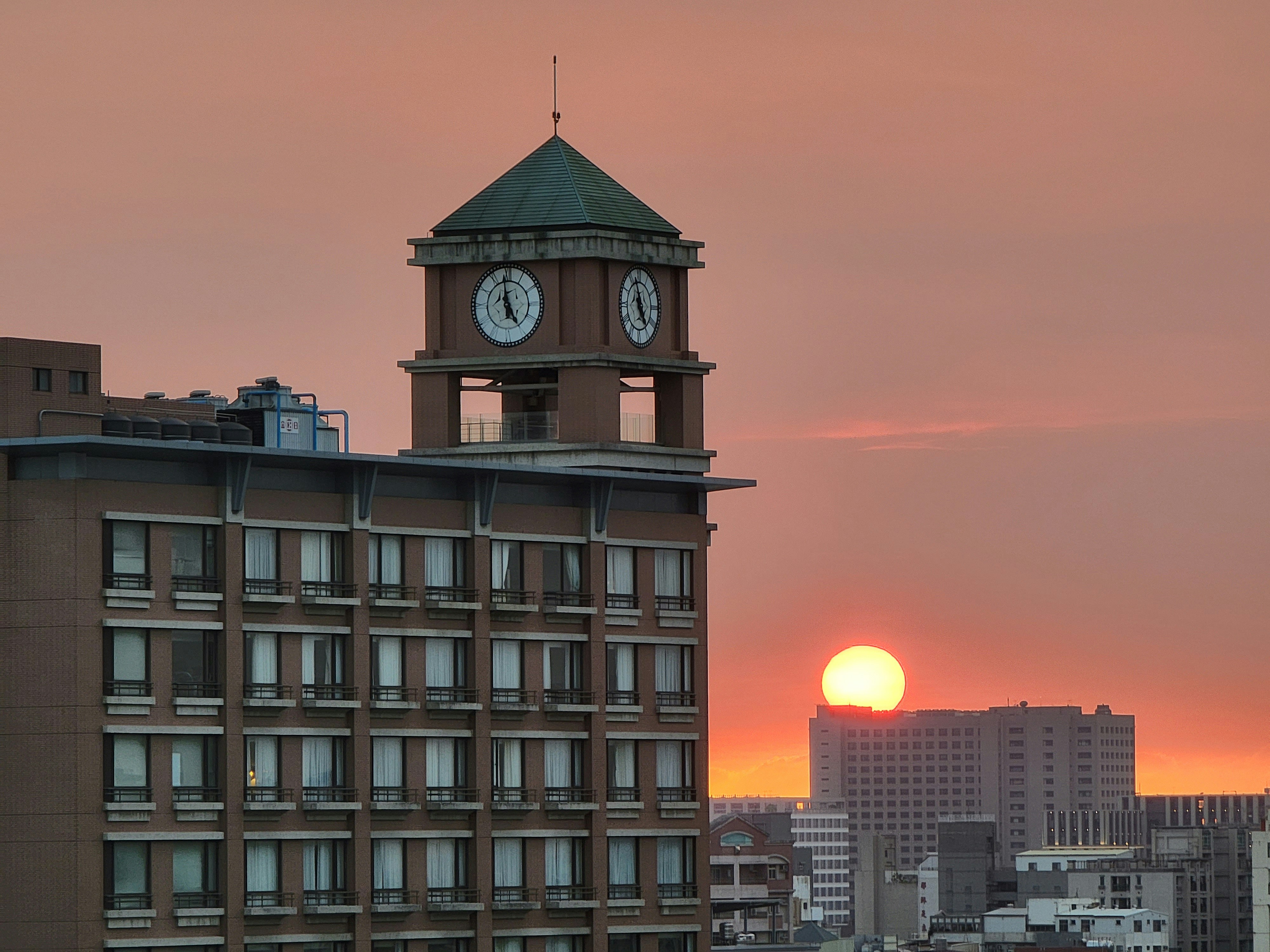 Dusk Over a Clocktower: Sunset Glow Across the City