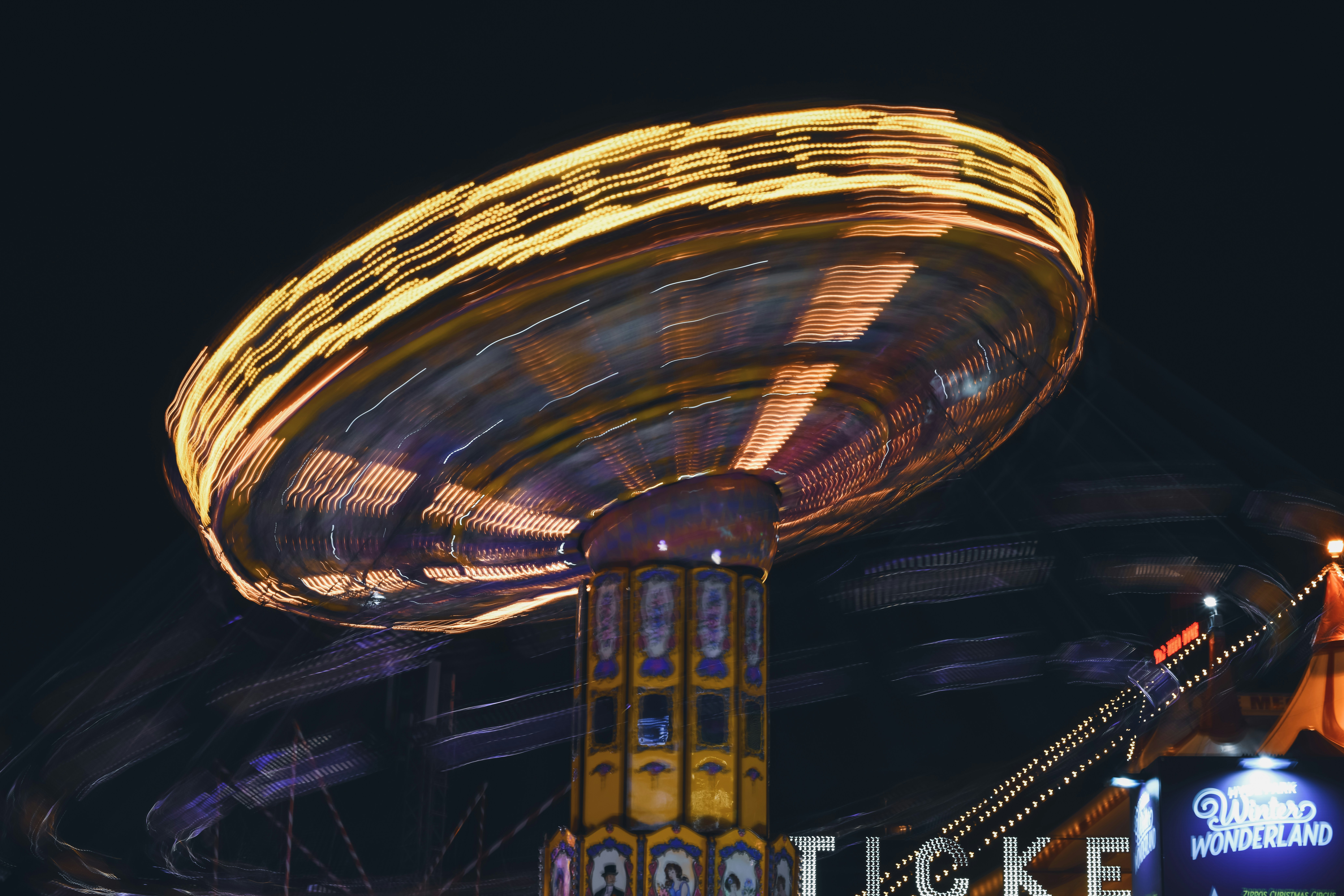 Neon Whirl: Night Carnival Ride in Motion Blur