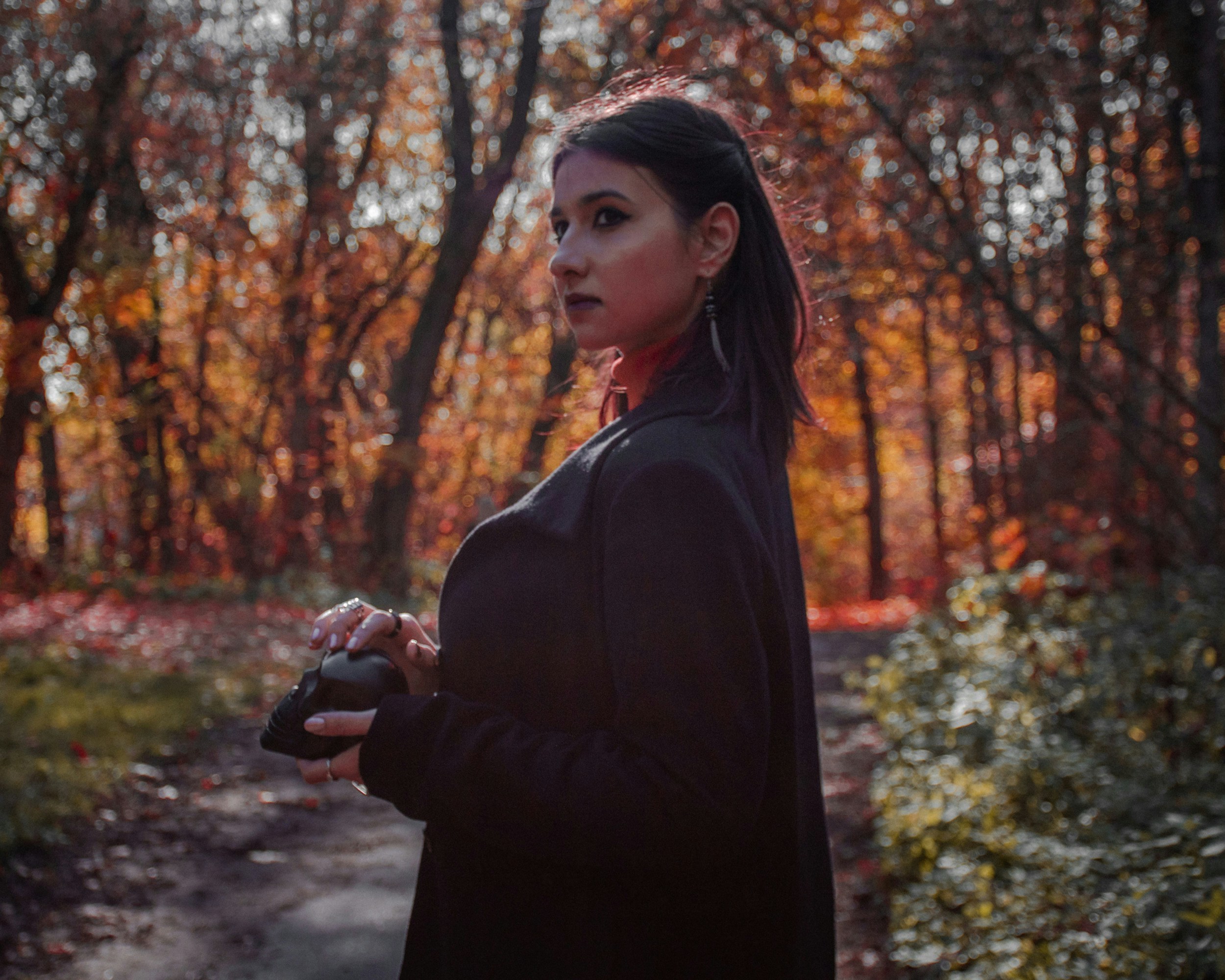 Autumn Portrait: Quiet Confidence Amid Orange-Flecked Woods