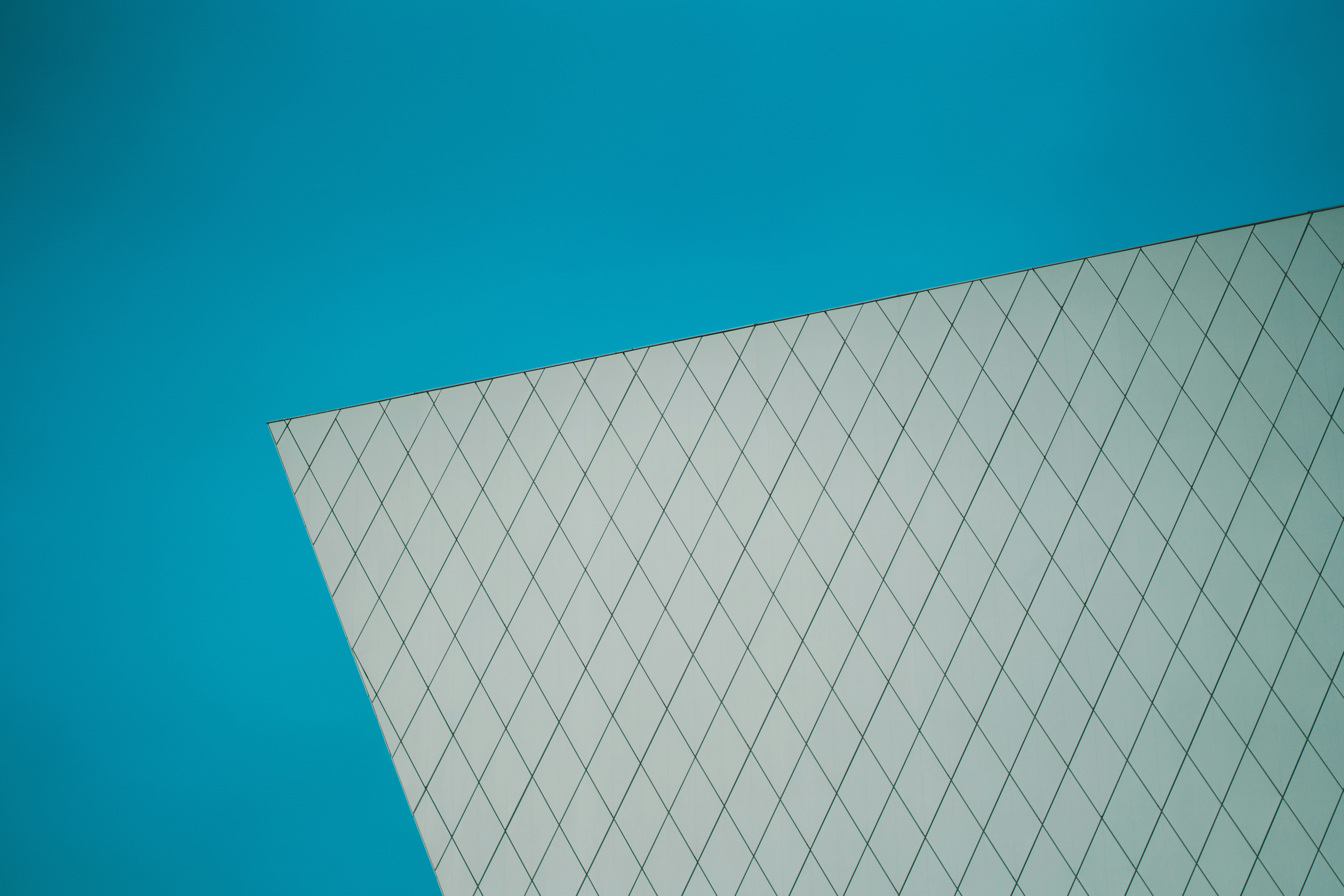 Sharp Diamond Facade Cutting Across a Blue Expanse