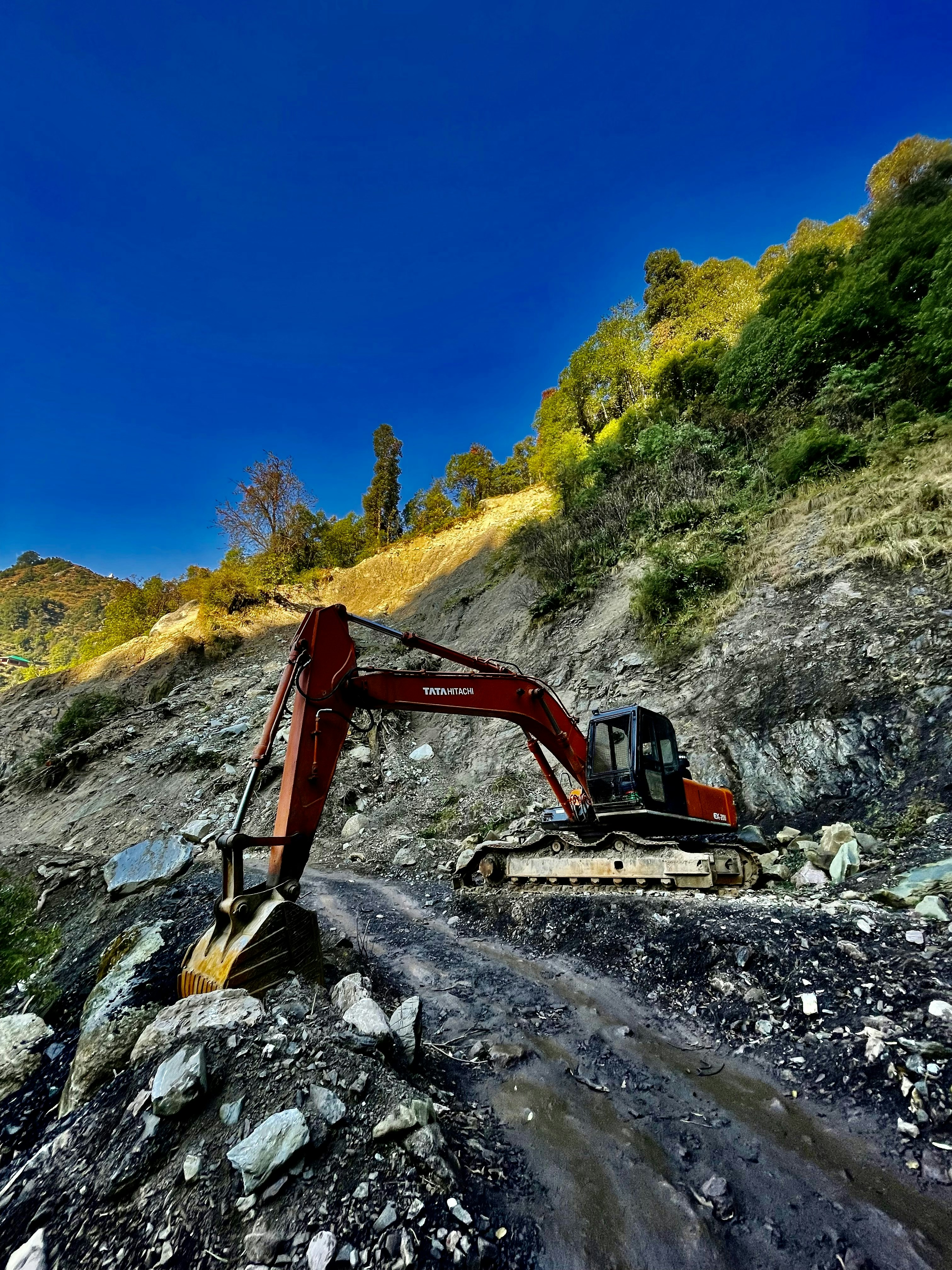 An excavator digging through a rocky area photo – Free Civil ...