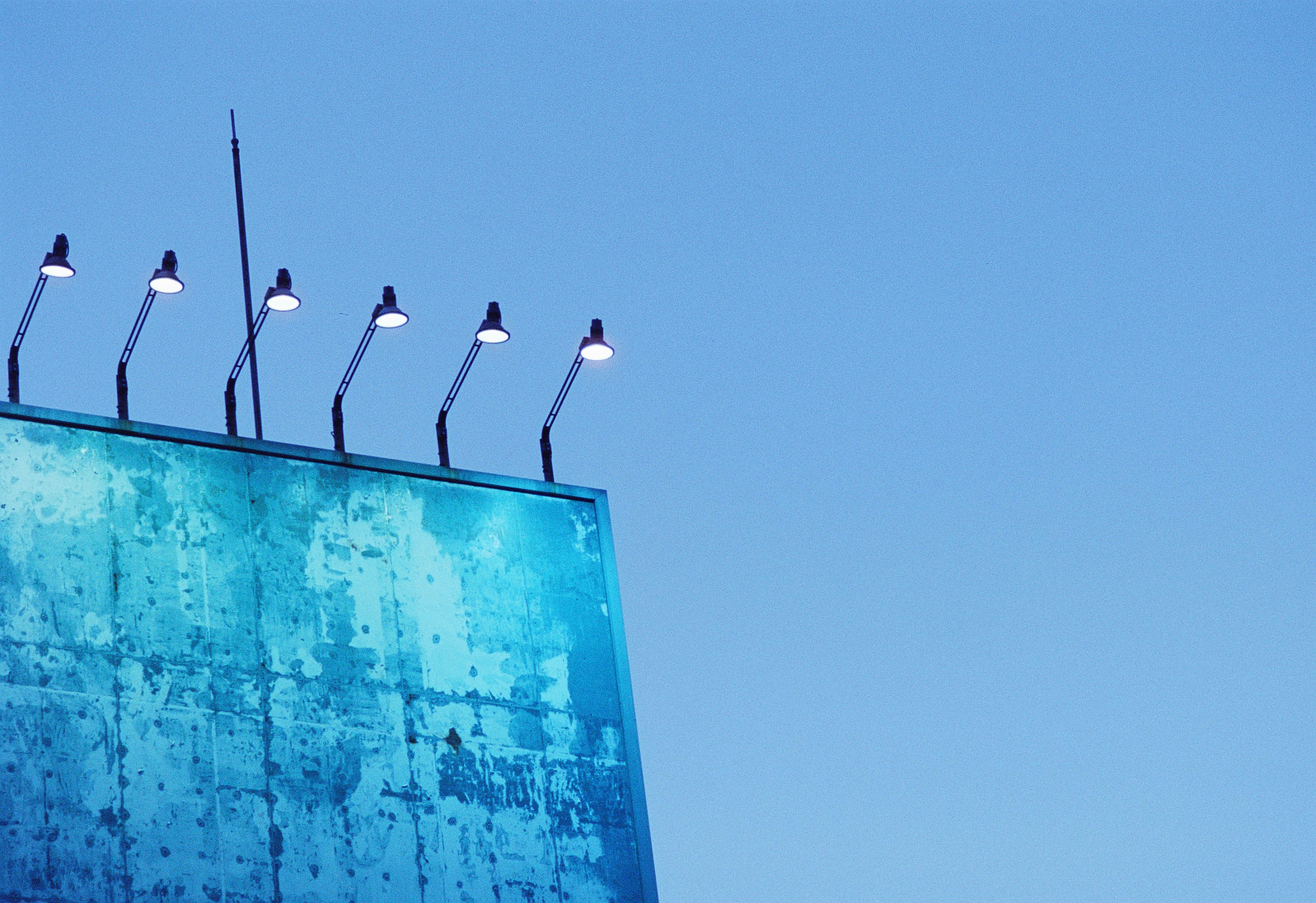 A tall building with a bunch of lights on top of it photo – Free ...