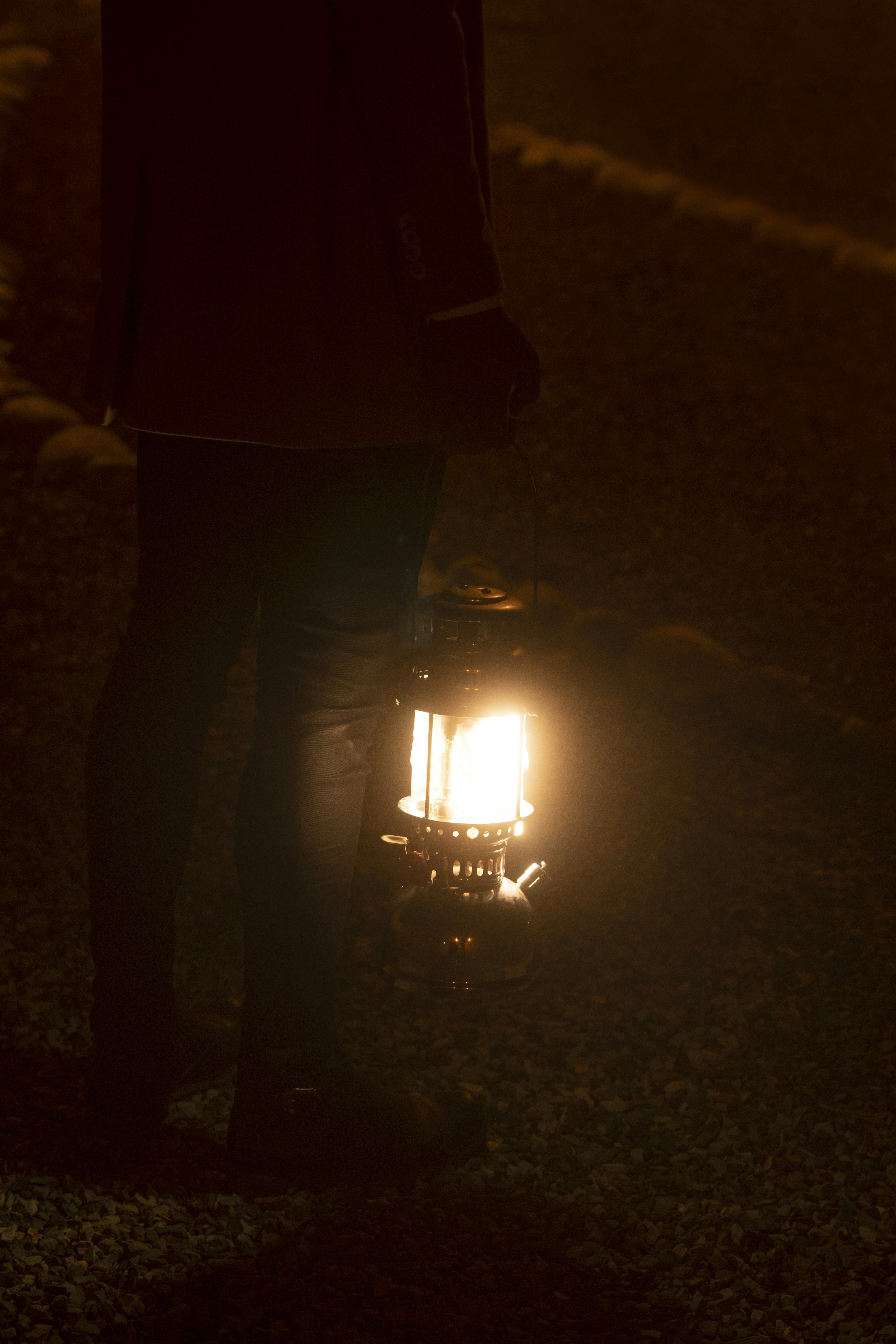 a person holding a lantern in the dark