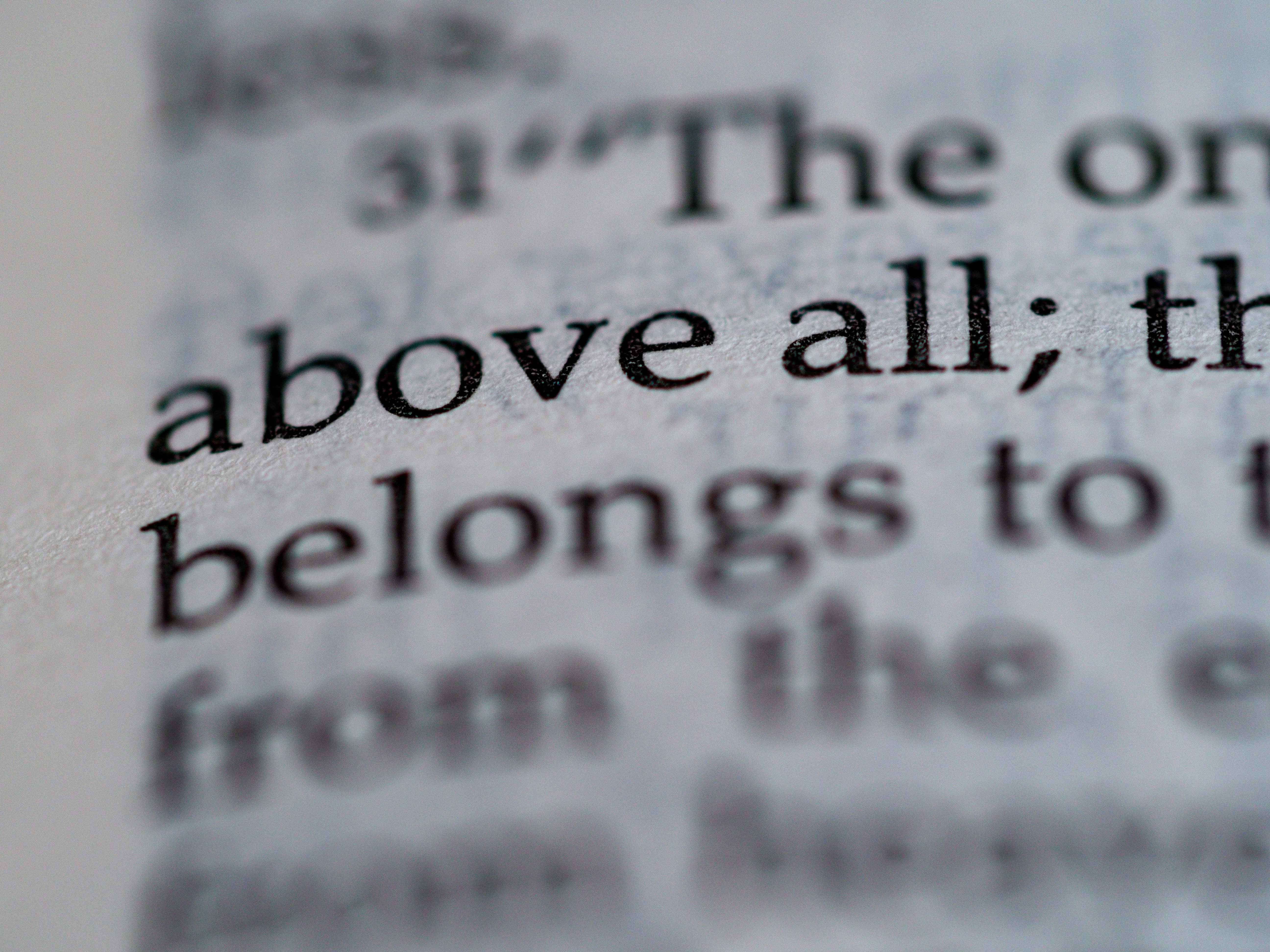 A close up of the word above all the belongs to the bible photo – Free ...