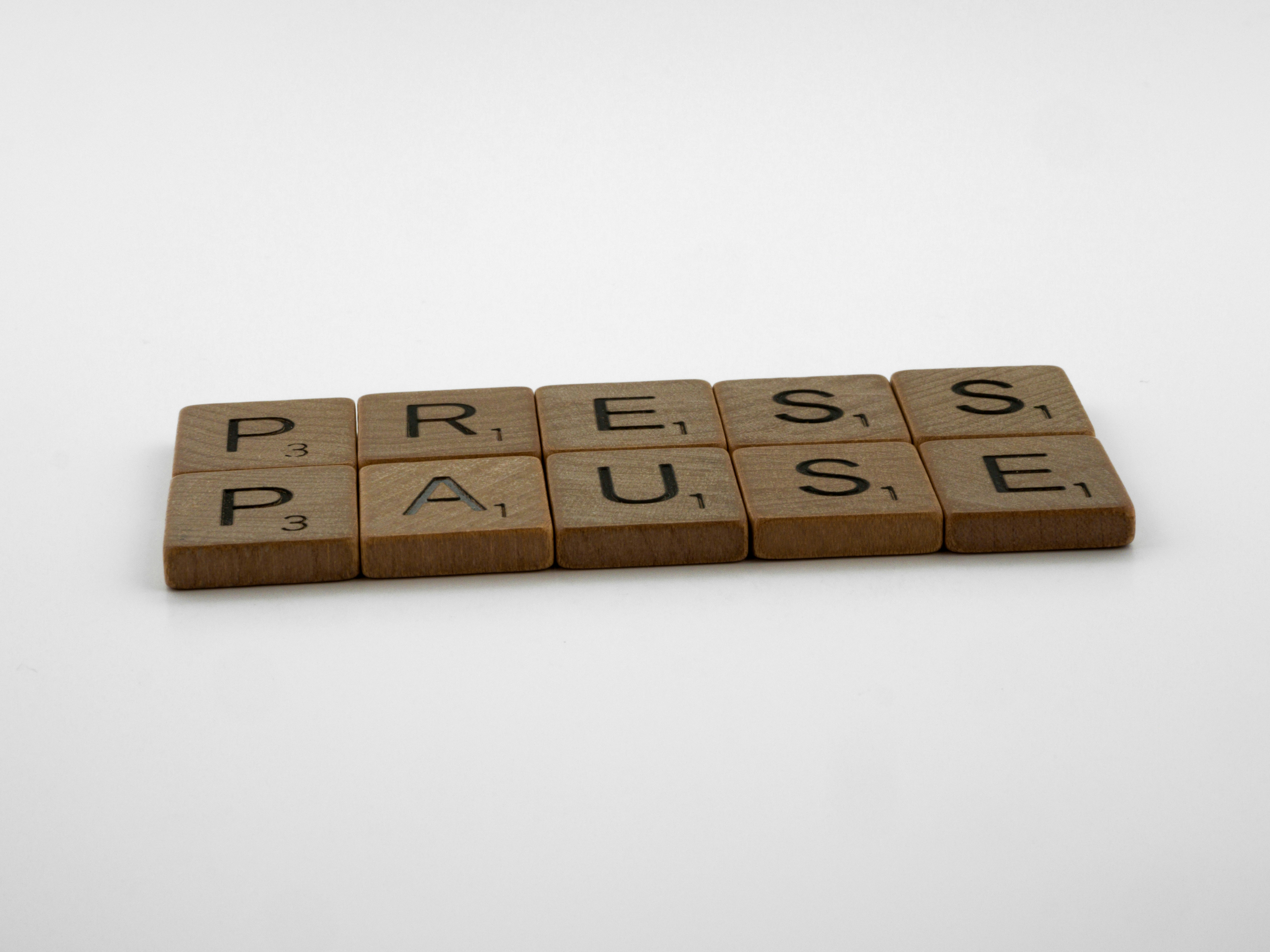 The word press pause spelled with scrabble tiles photo – Free Grey ...