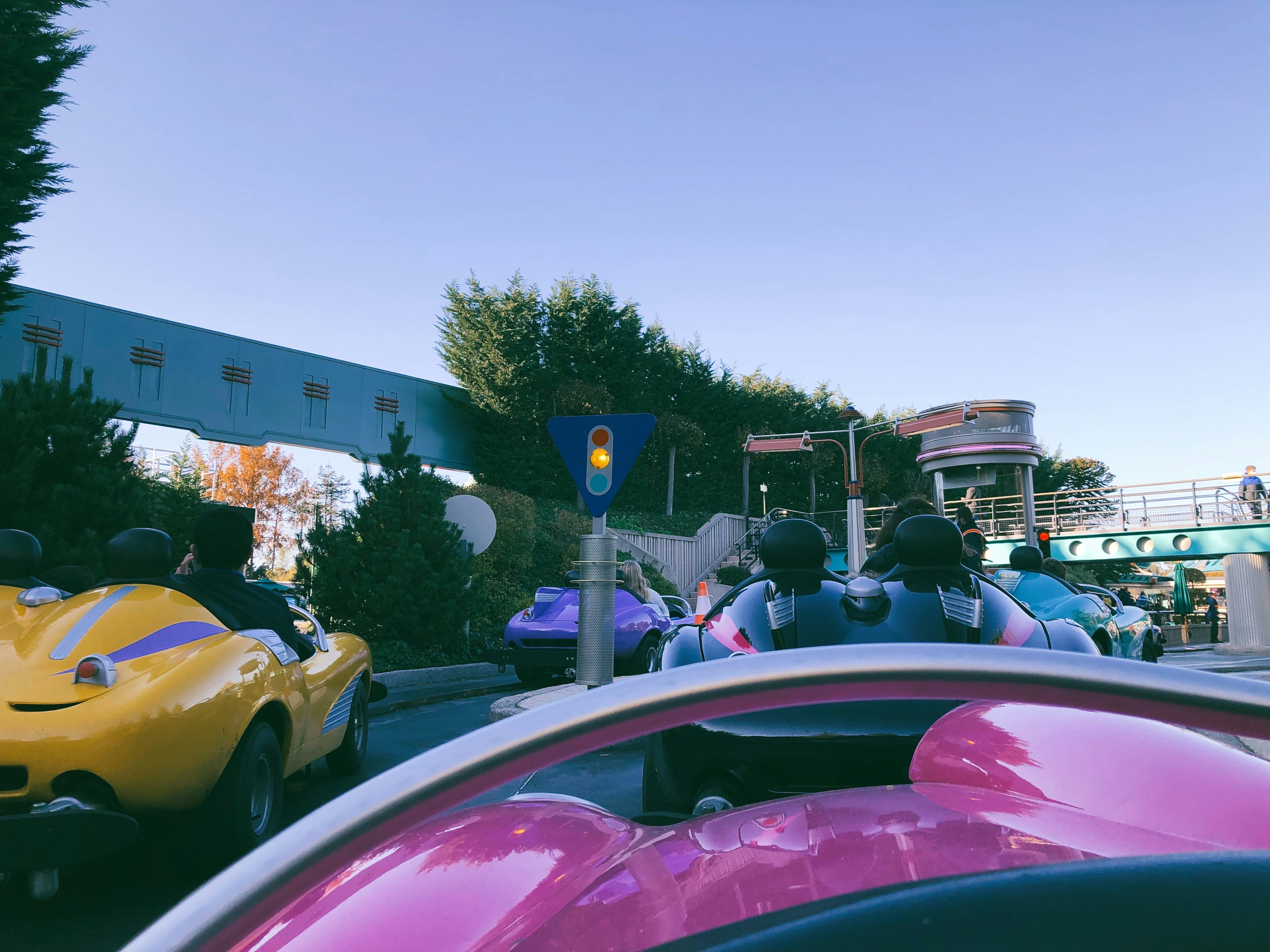 A group of people riding in bumper cars down a street photo – Free ...