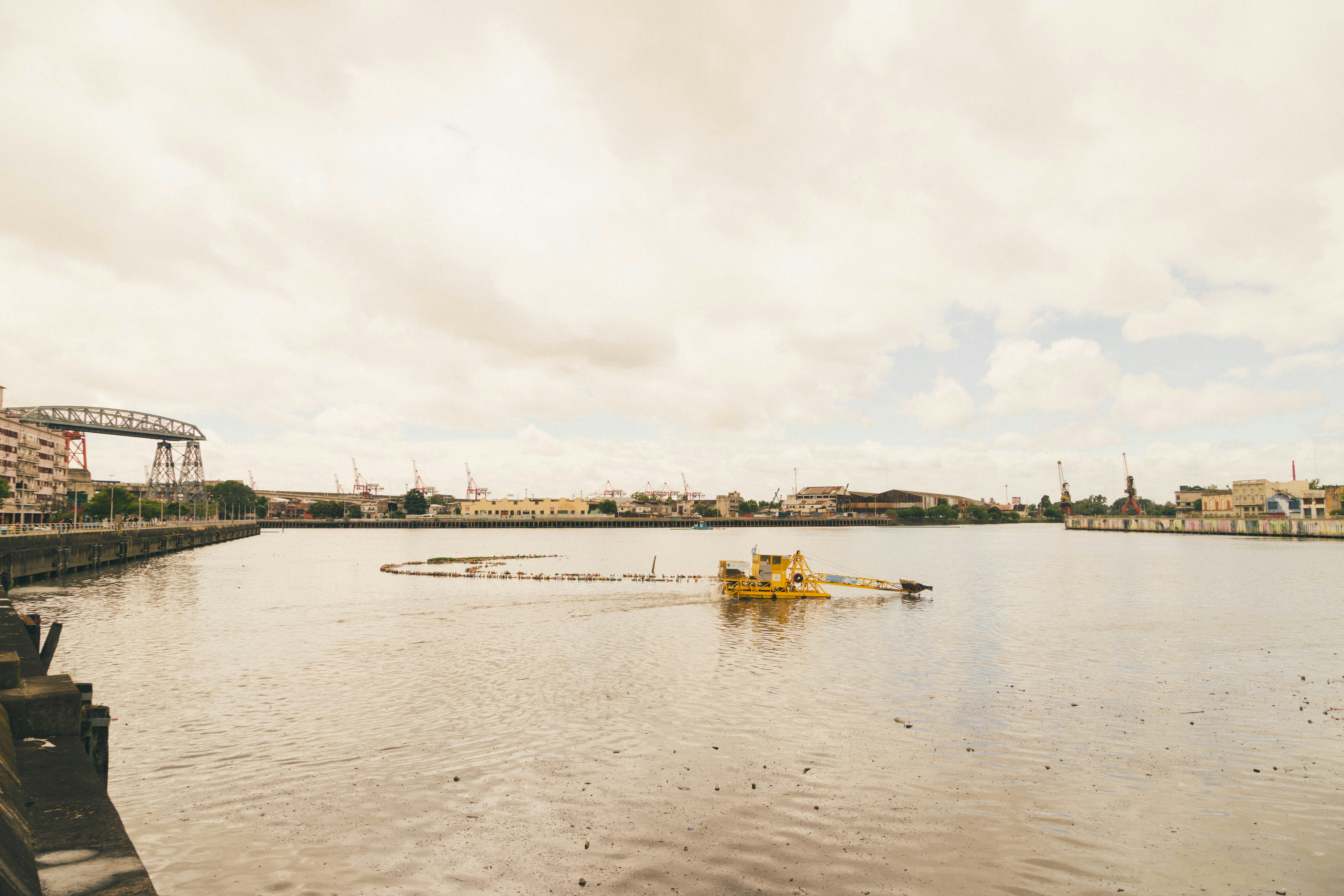 River Work: A Yellow Tug Ploughs a Barred Channel