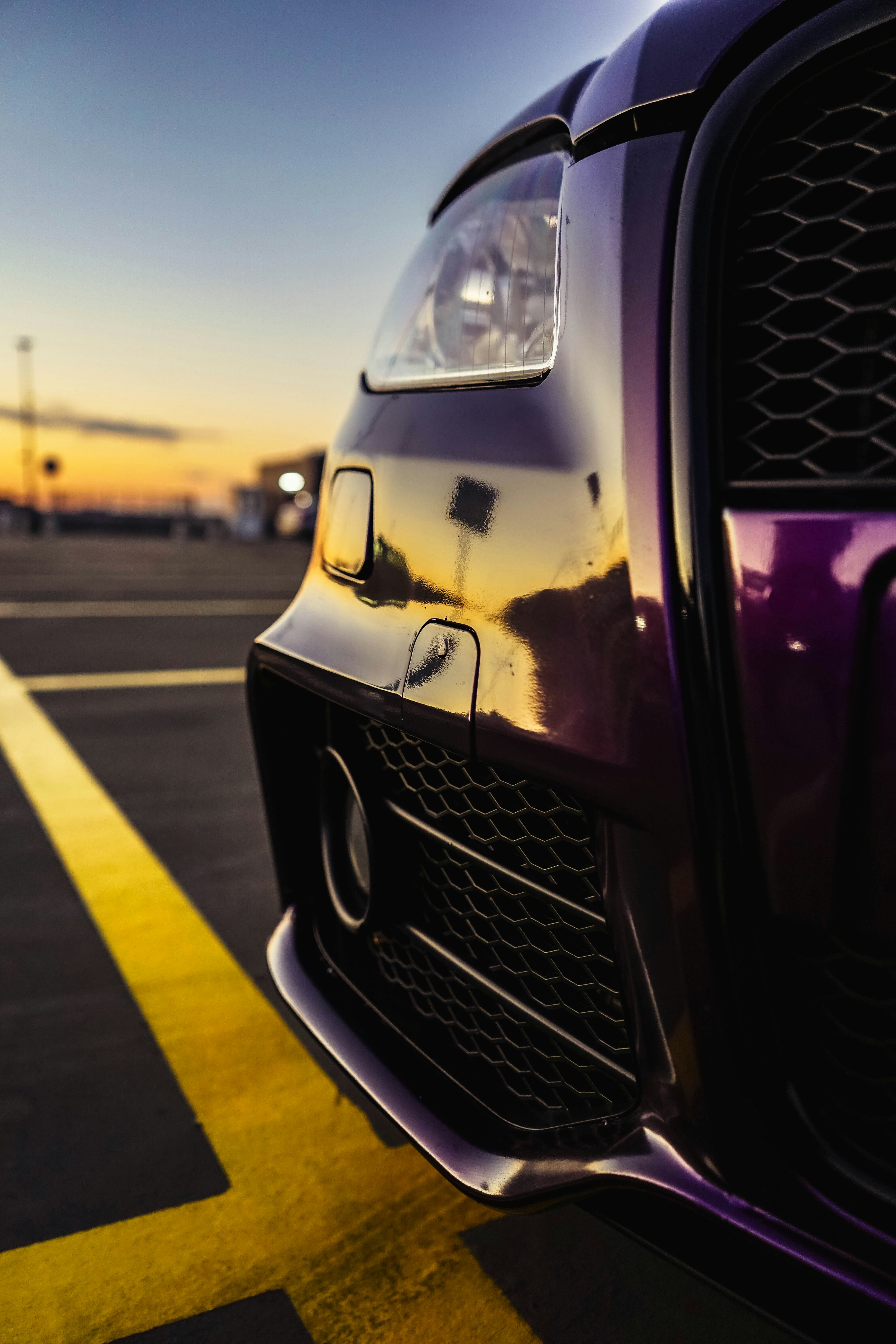 Sunset Reflections on a Violet Front: Close-Up of a Purple Sports Car