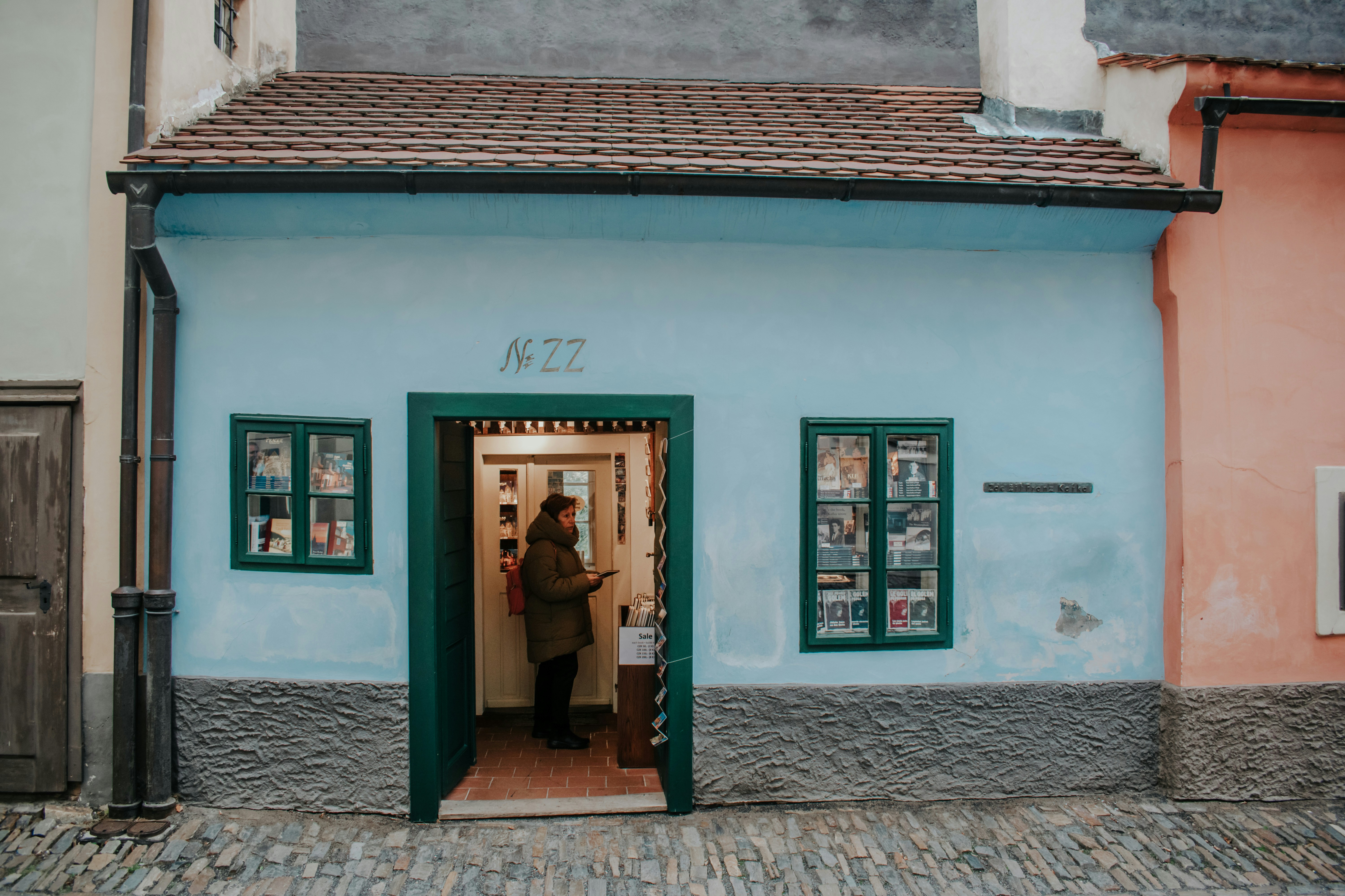 Pastel Portal: A Quiet Entrance Framed by Cobblestone Street