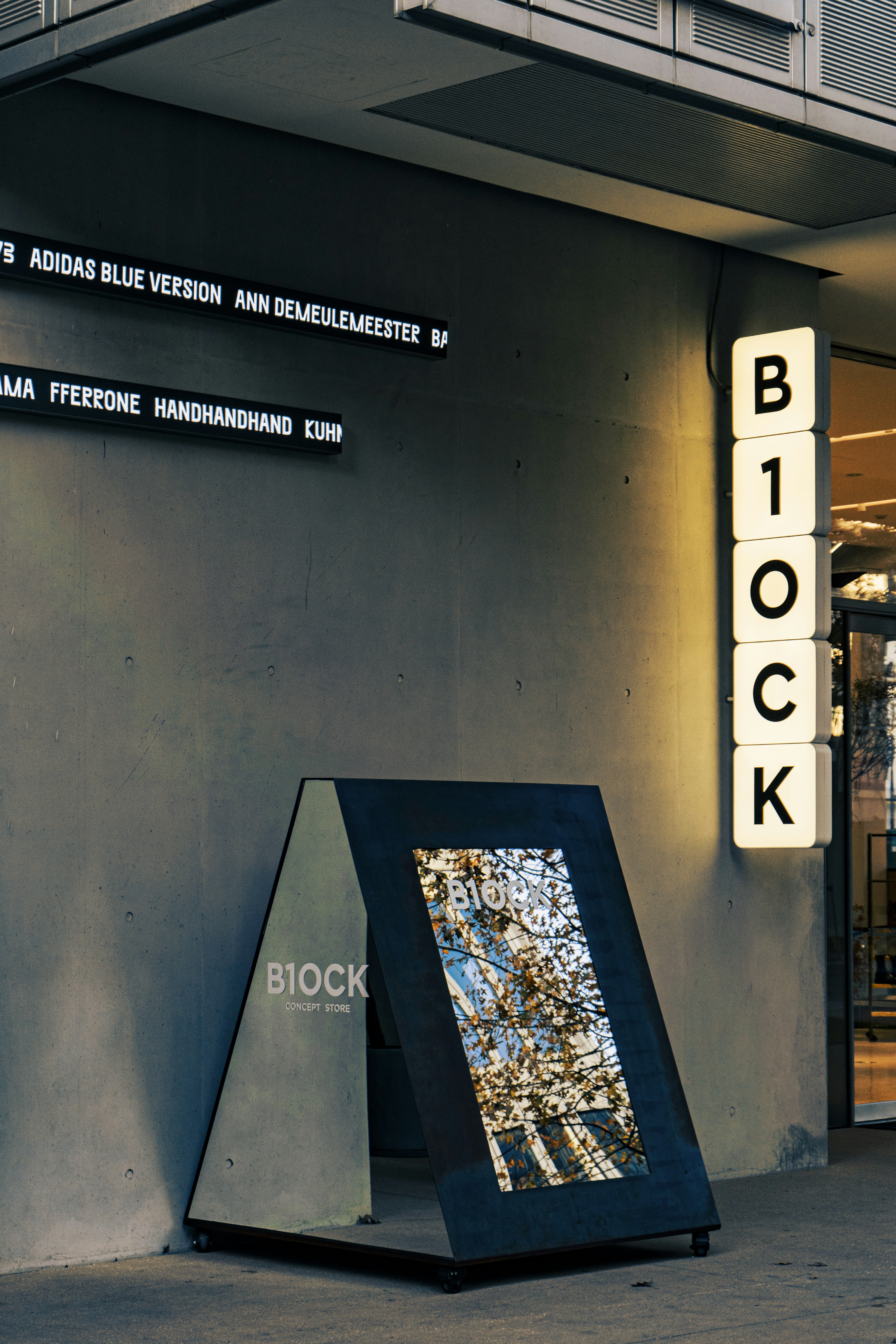 Block Signage and Glass Reflection: A Quiet Urban Corner
