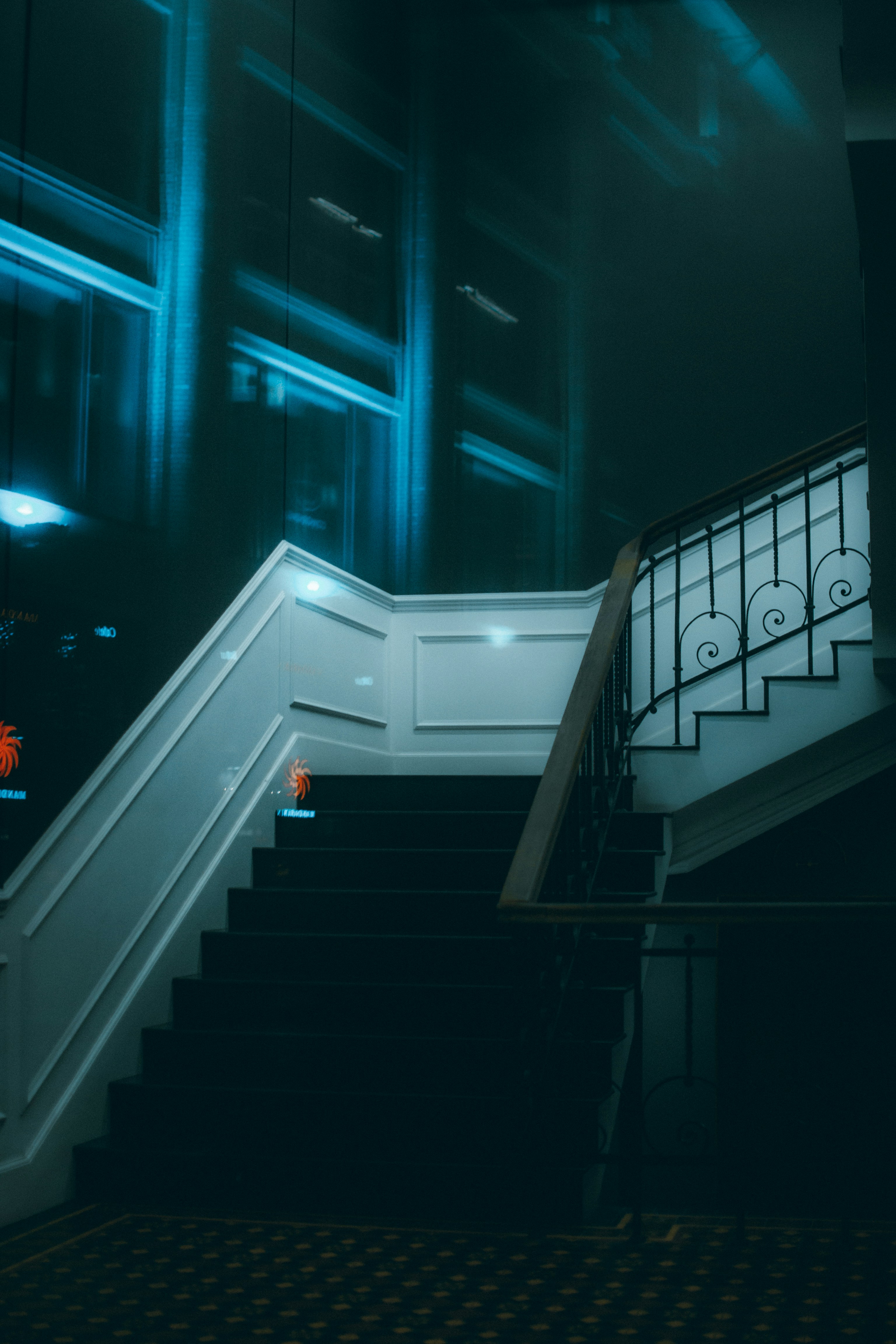 Blue Neon Stairwell in a Dim Hotel Lobby