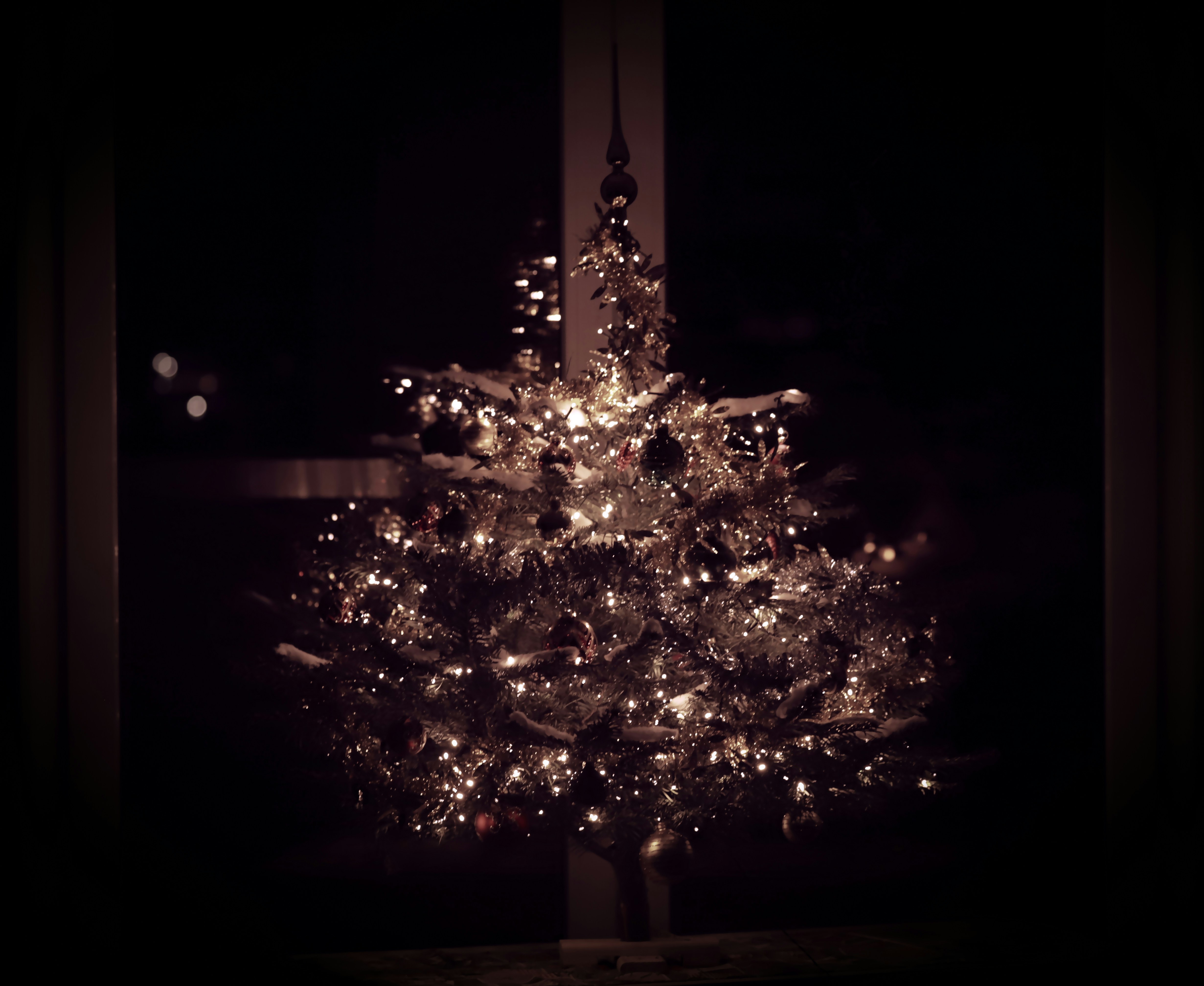 a lit up christmas tree in a dark room