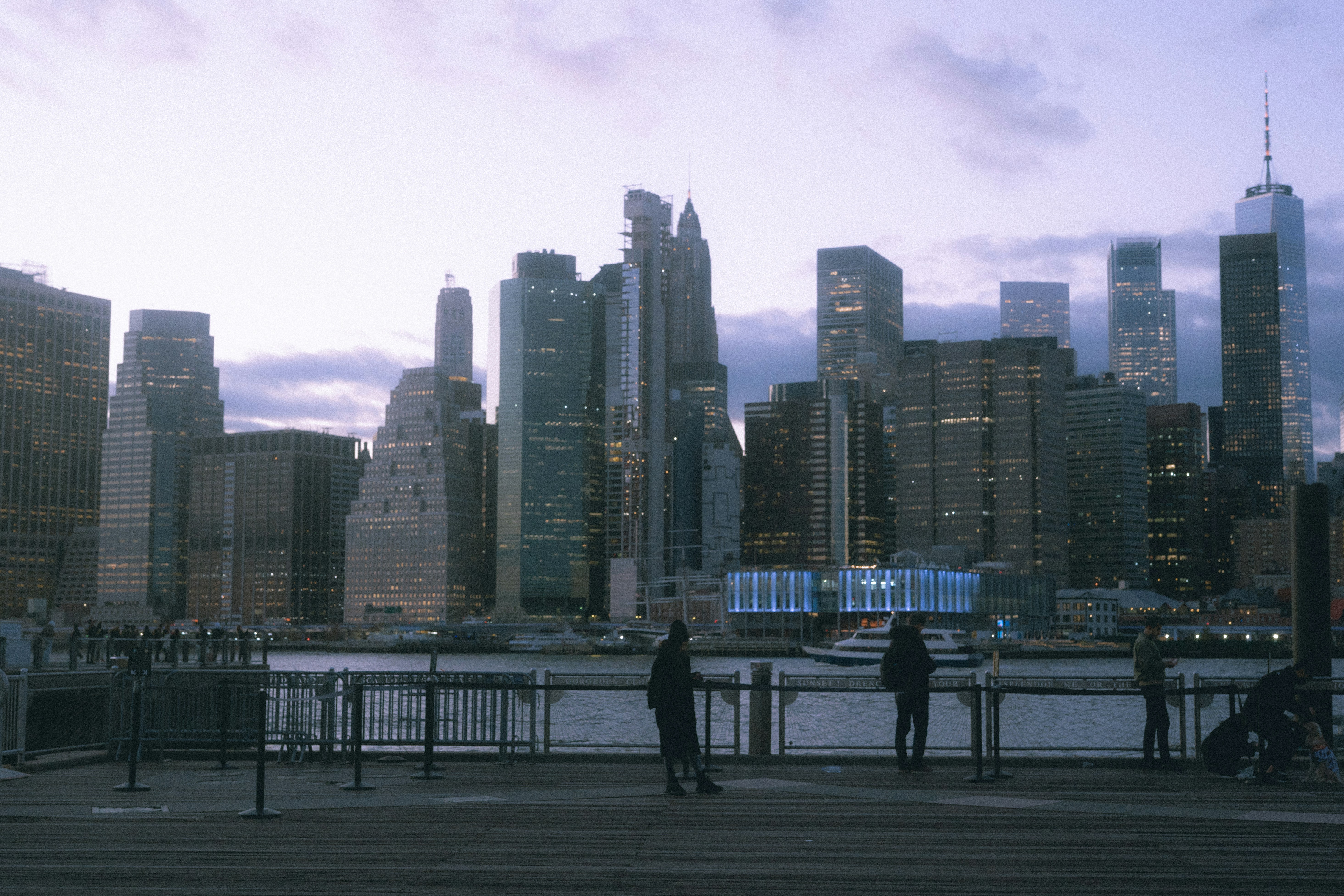 Dusk by the Harbor: Silhouettes Against a Neon-Blue Skyline