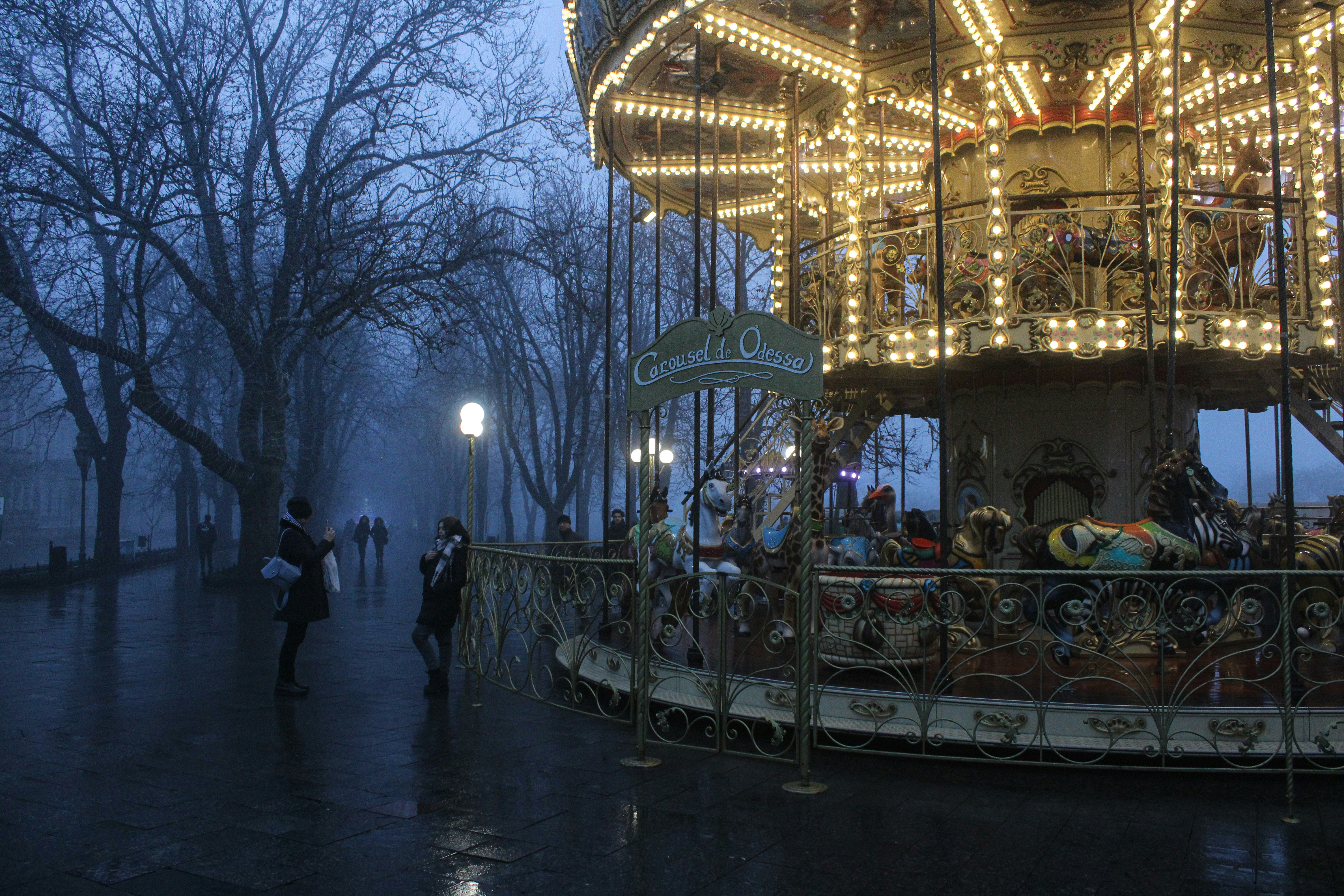 Blue Hour Carousel: Neon Ornaments in Quiet Fog