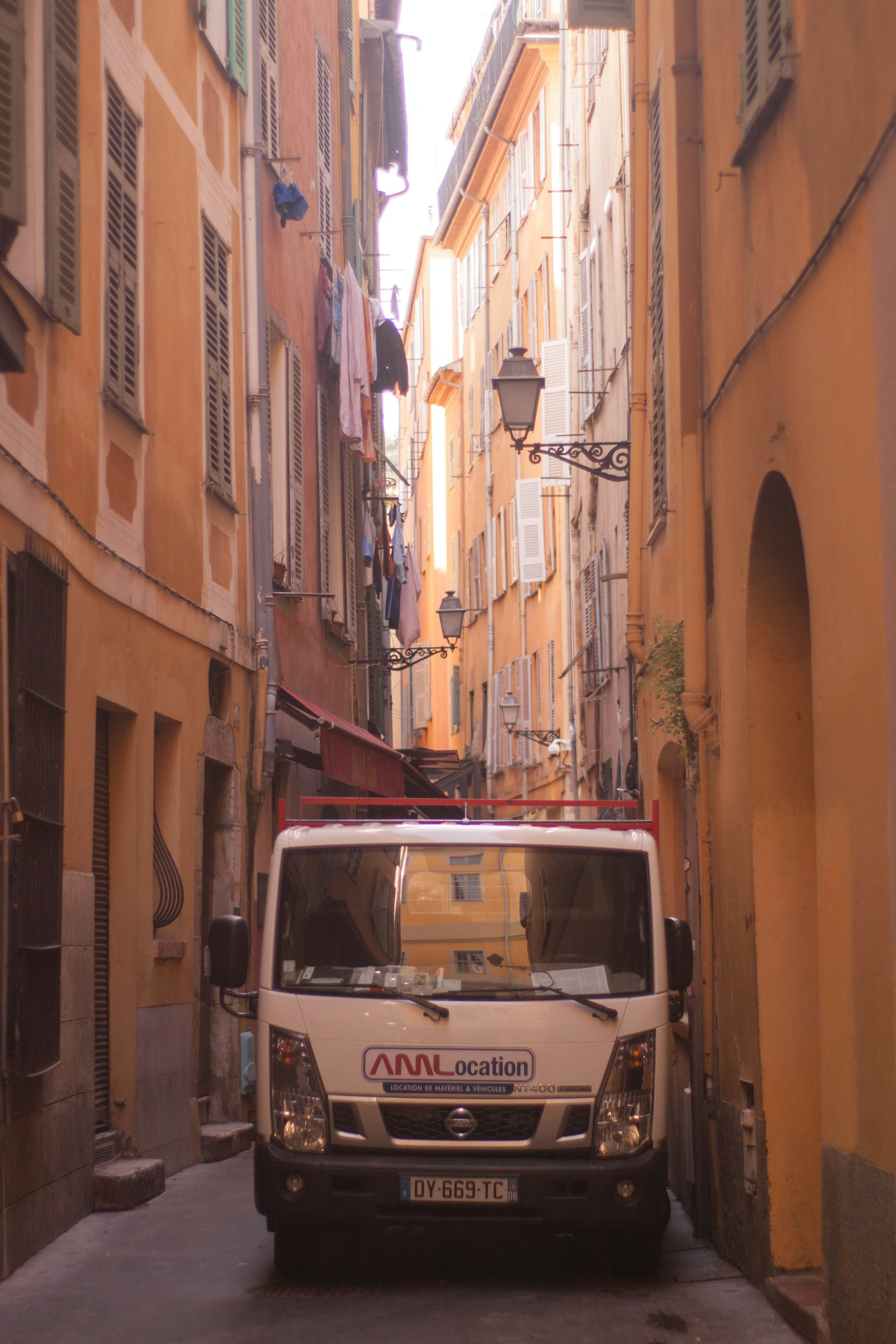 Calle de Luz: A sunlit alley converges on a waiting delivery truck