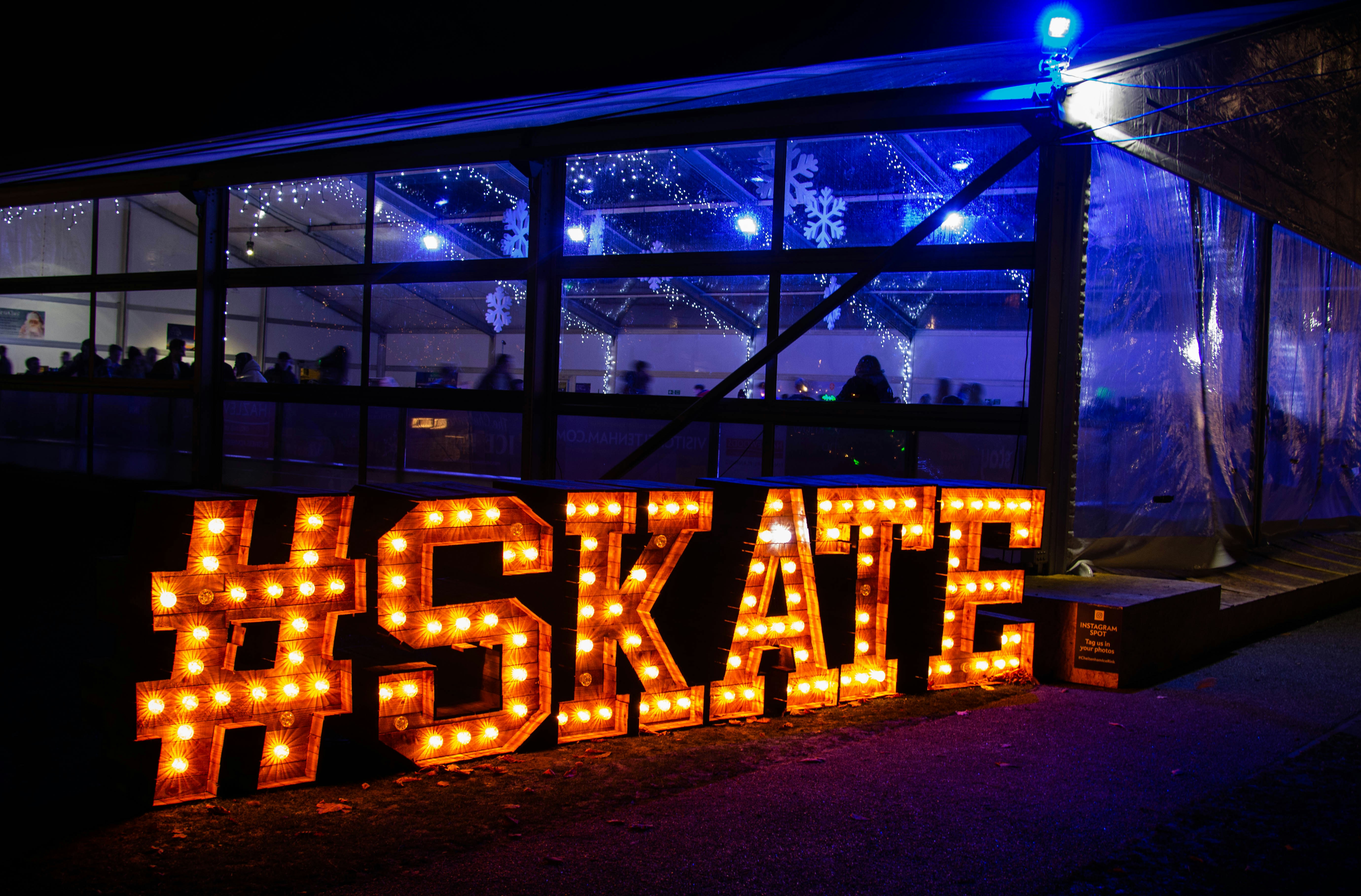 Glowing Skate Sign Illuminates Night-time Arena