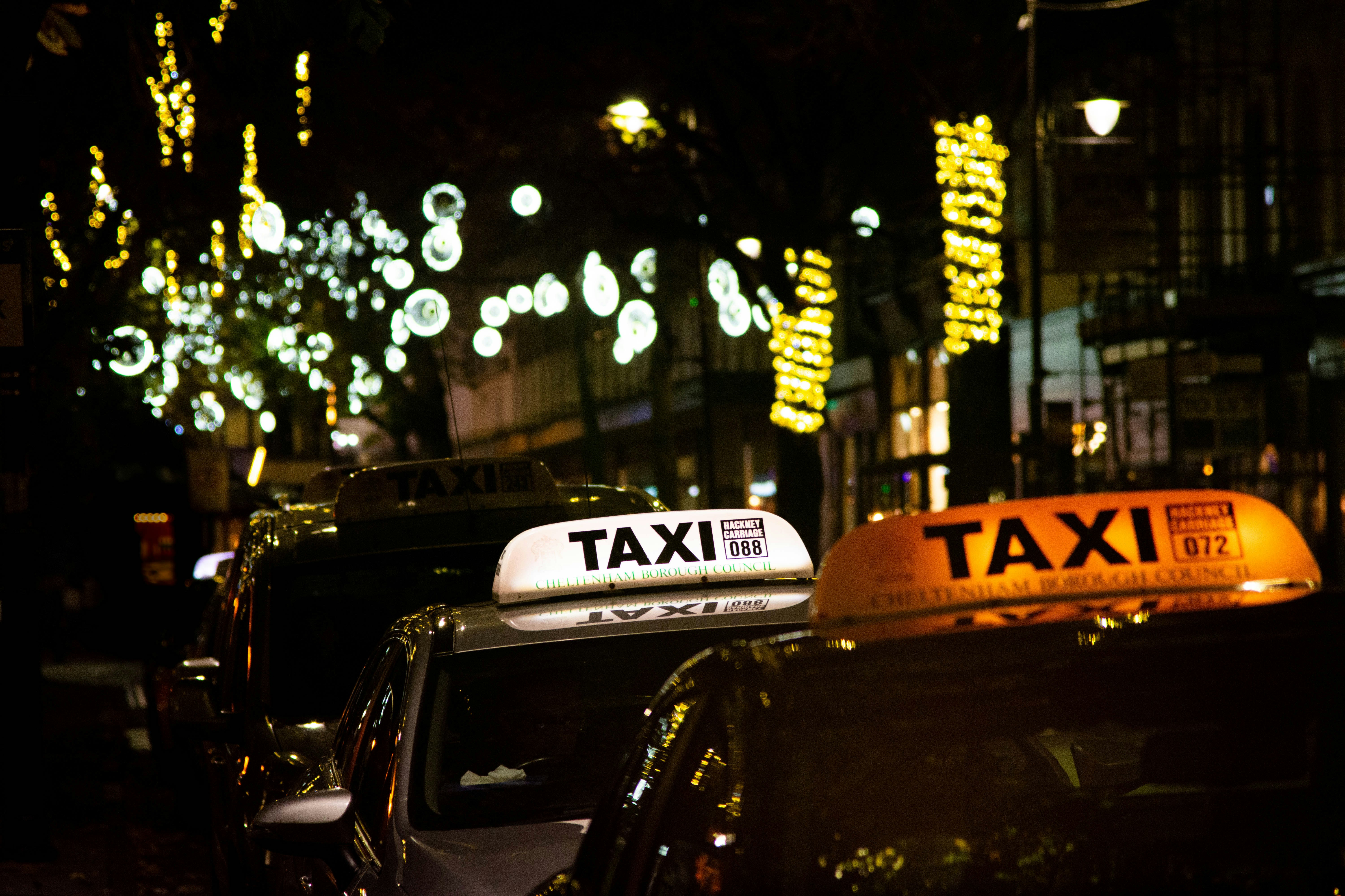 A taxi cab parked in front of a taxi cab at night photo – Free Car ...