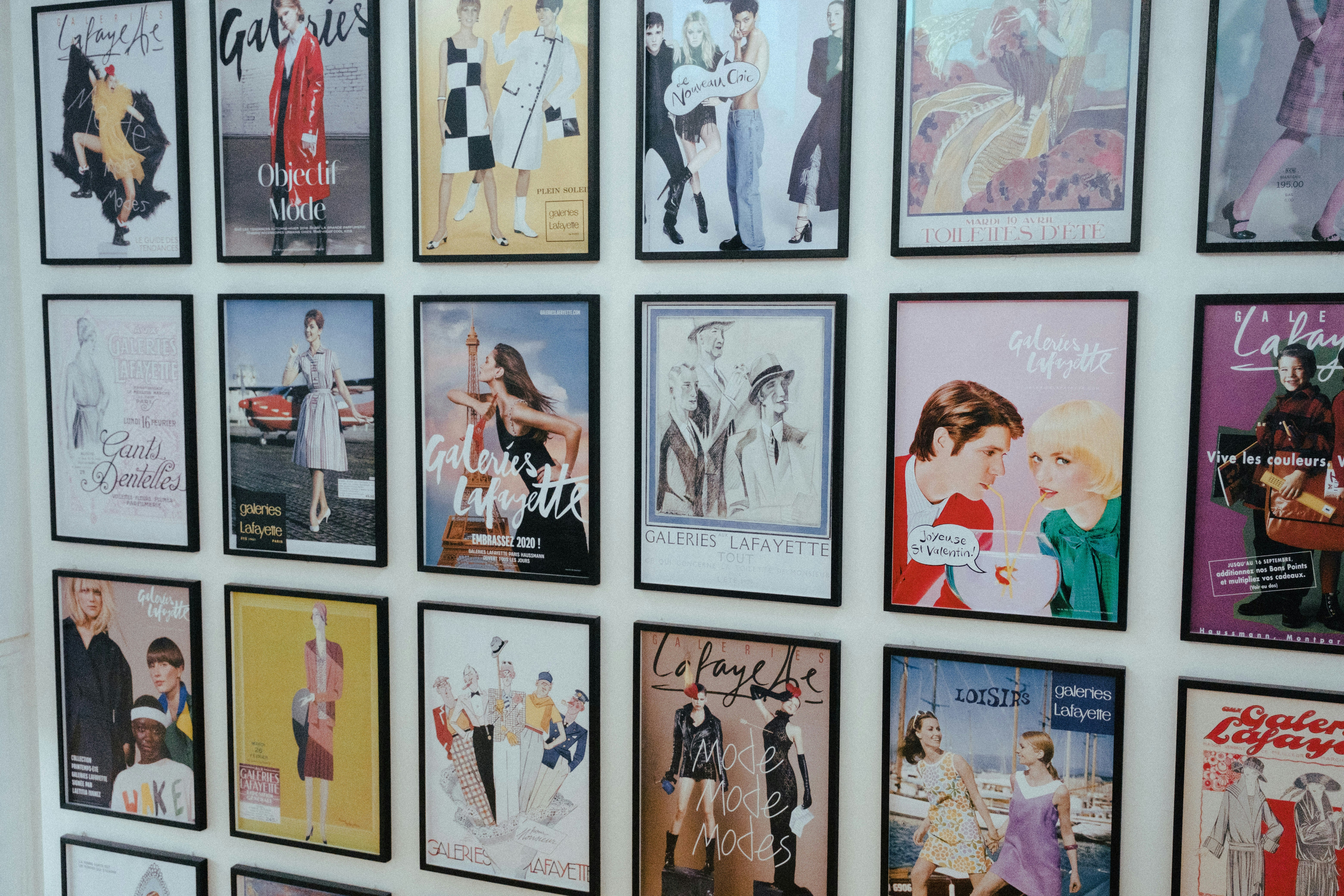 A wall with a bunch of posters on it photo – Free Art Image on Unsplash