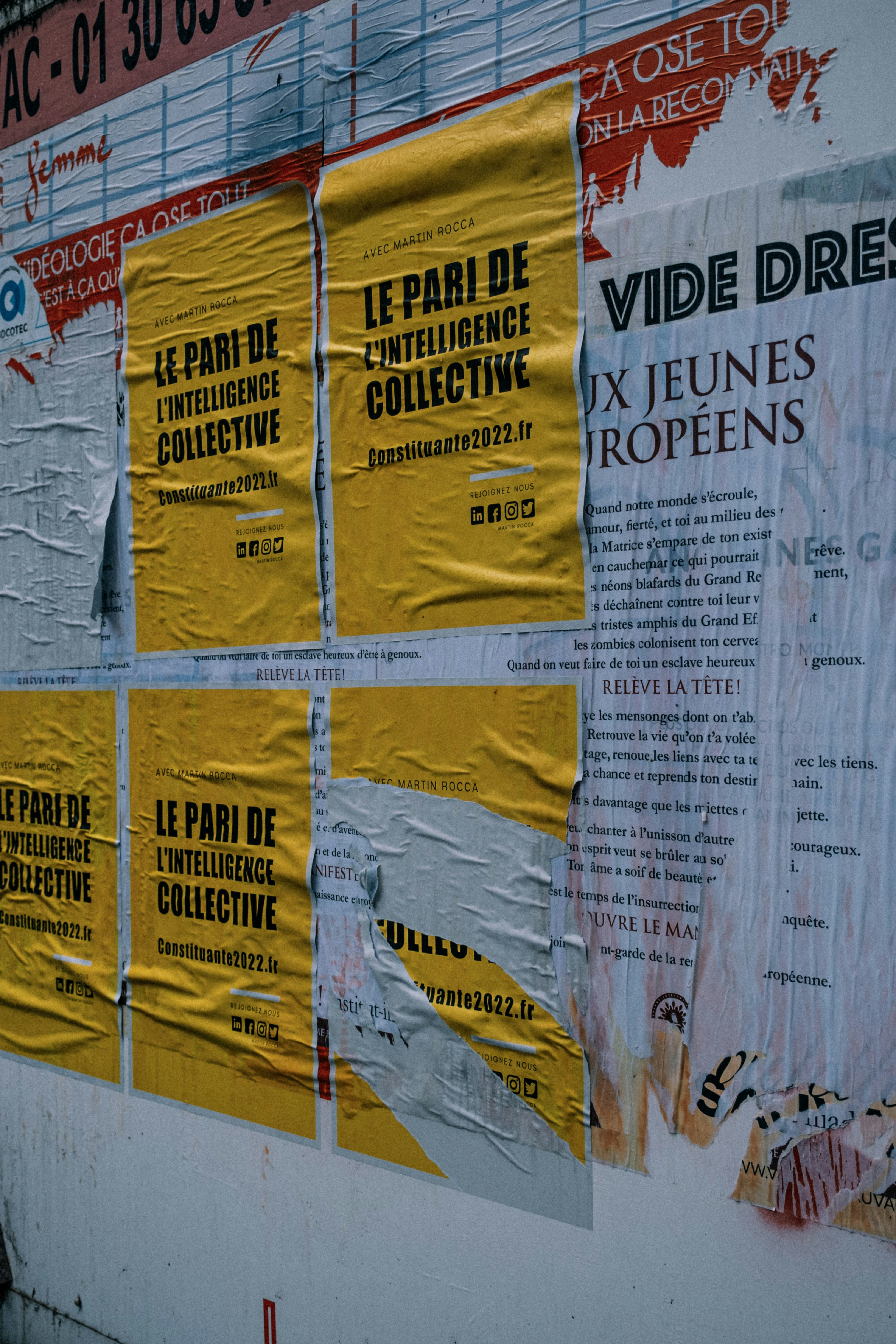 A bunch of posters on the side of a building photo – Free Green Image ...