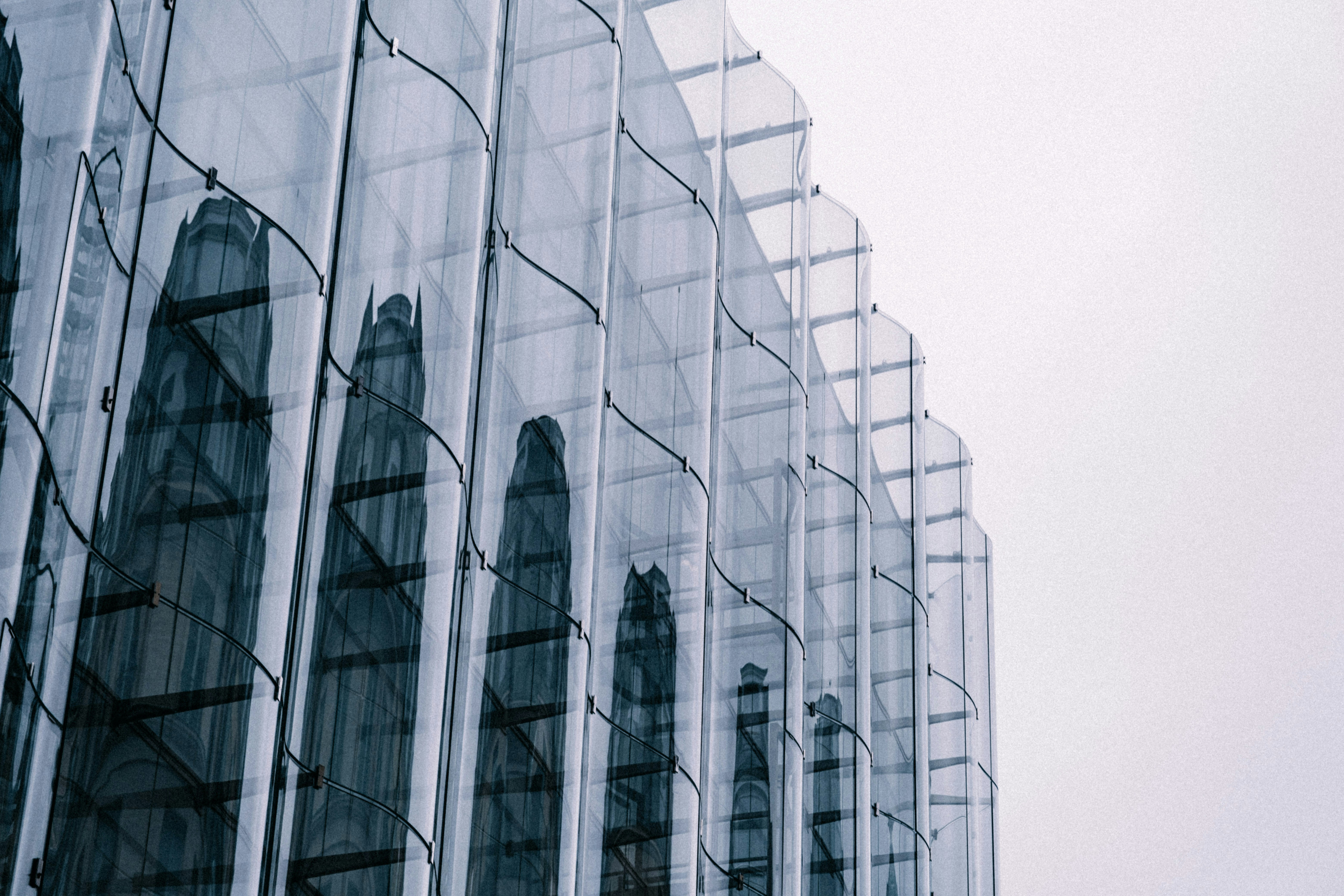 Arched Glass Facade: Vertical Echoes in Quiet Light