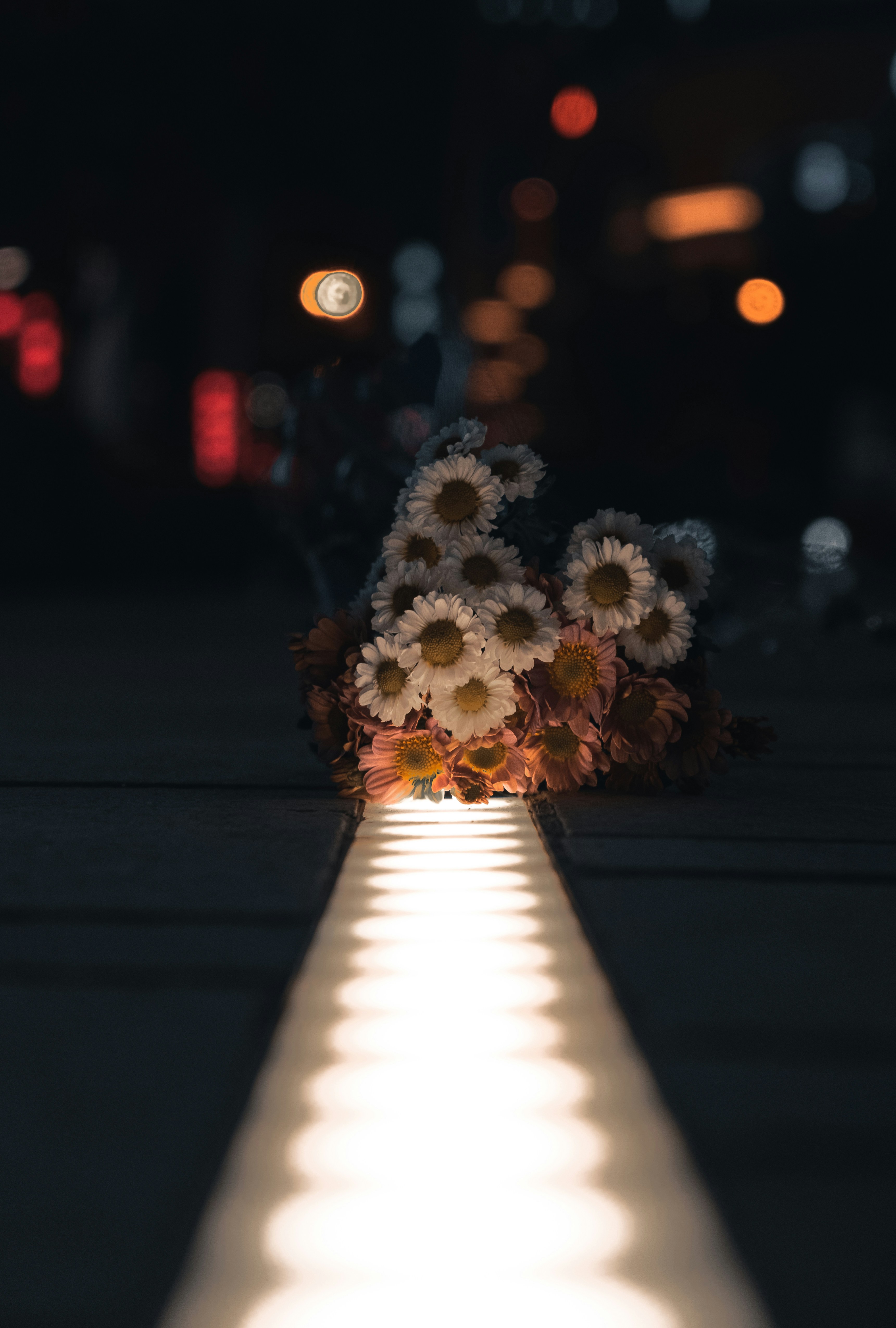 a flower arrangement sitting on the side of a road