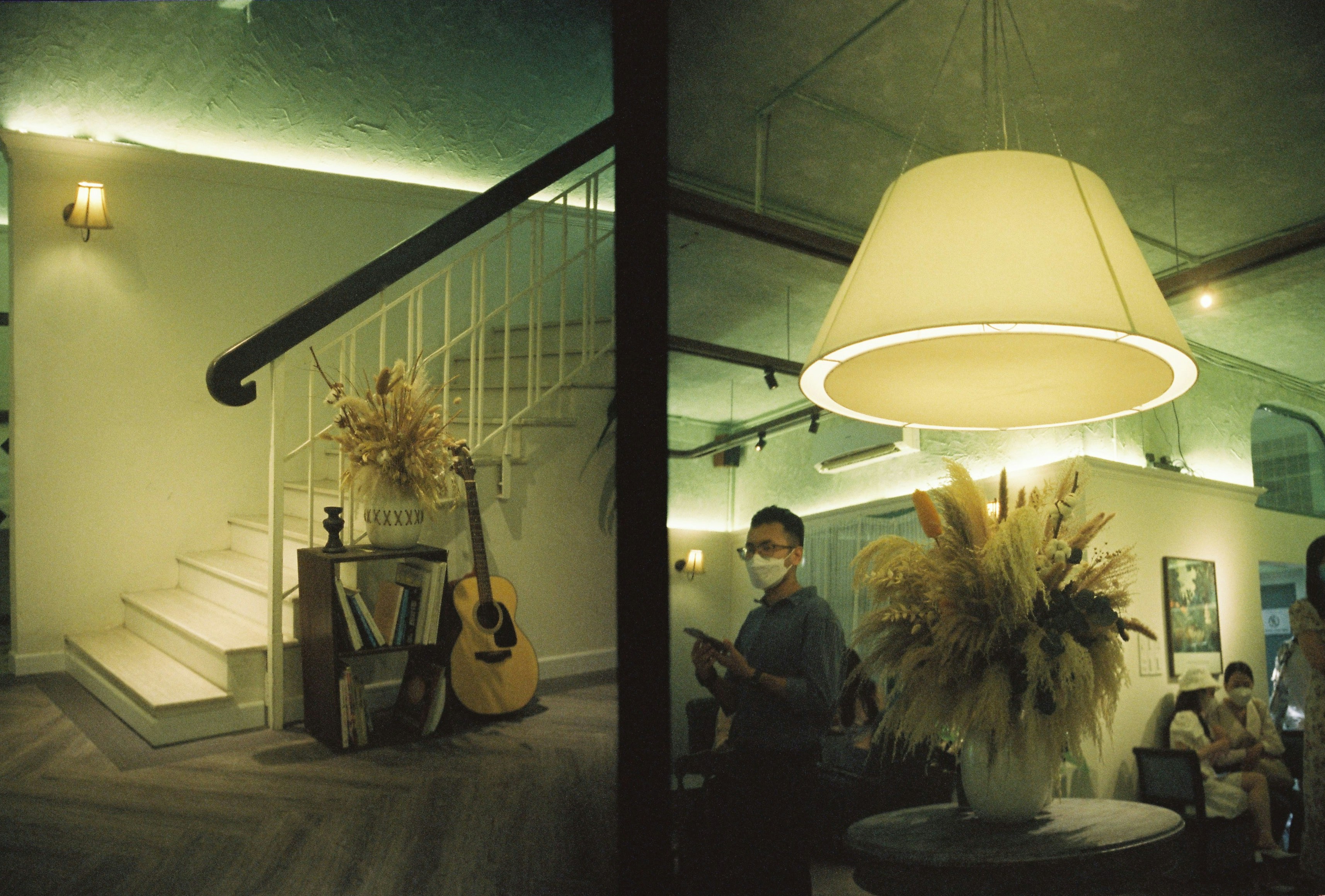 Quiet Corner of a Cozy Cafe: Guitar, Staircase, and Warm Light