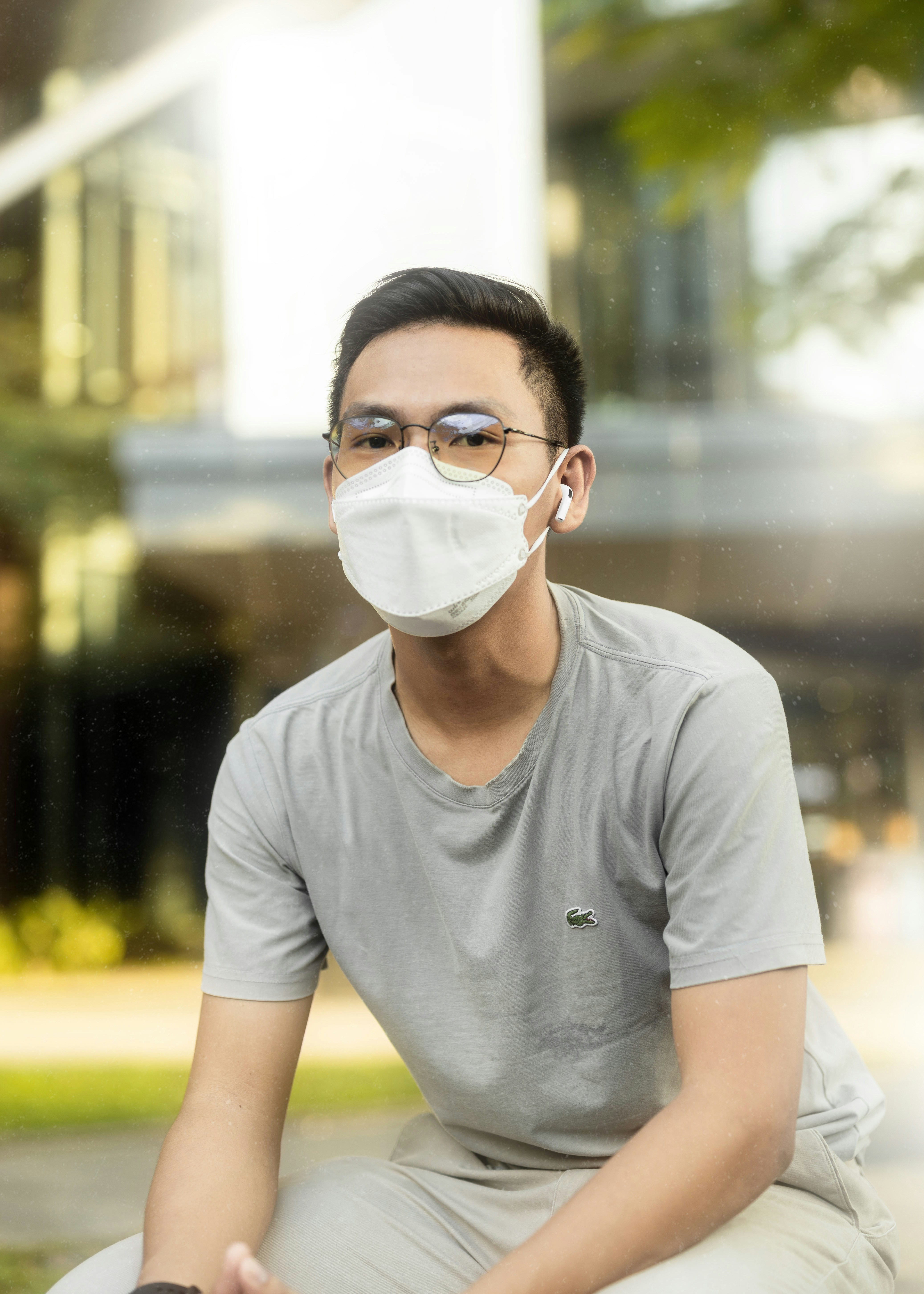 A man wearing a face mask sitting on a bench photo – Free Wallpaper ...