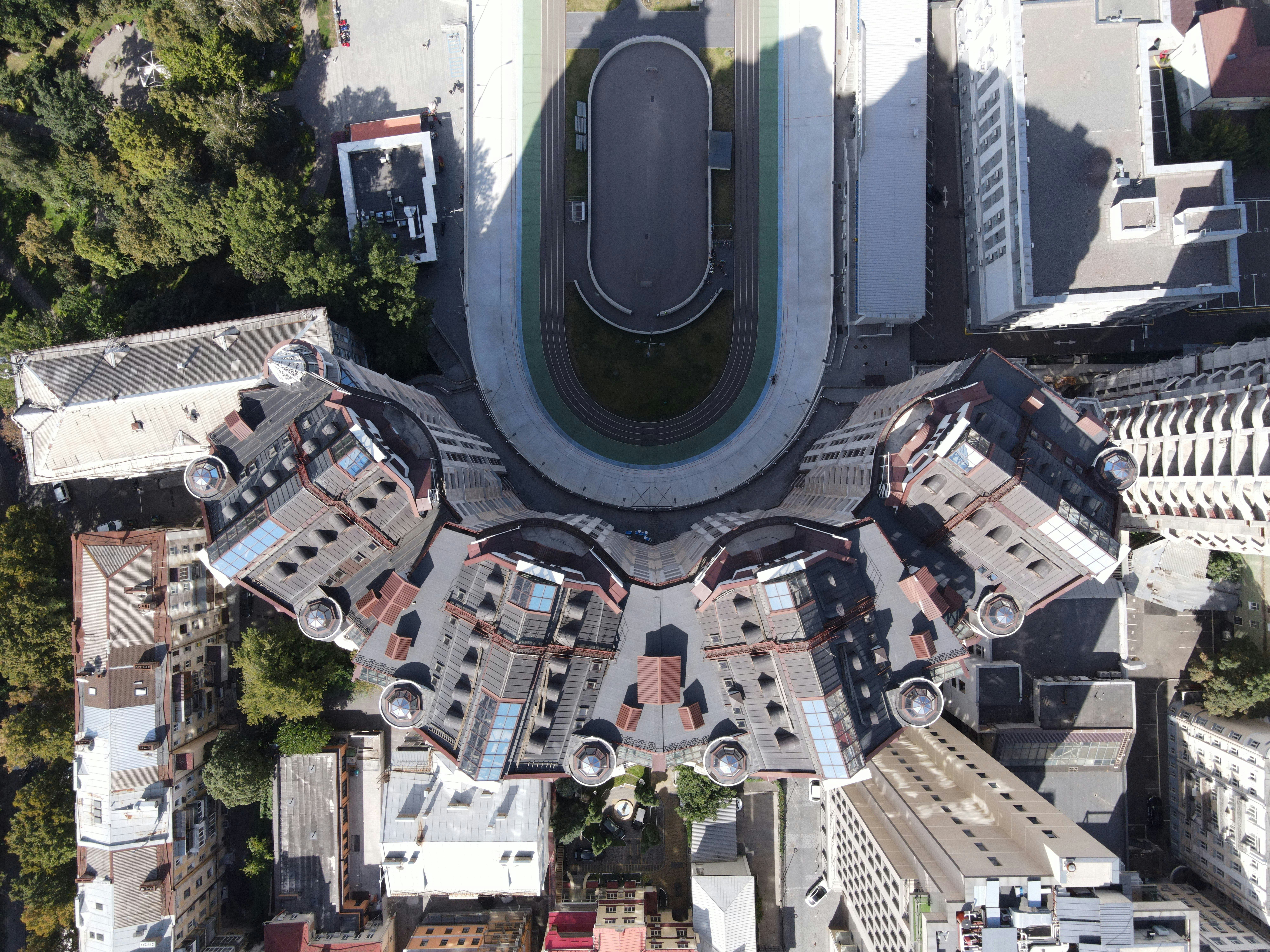 Rooftop Ring: An Aerial Portrait of an Oval Arena Amid Dense Towers