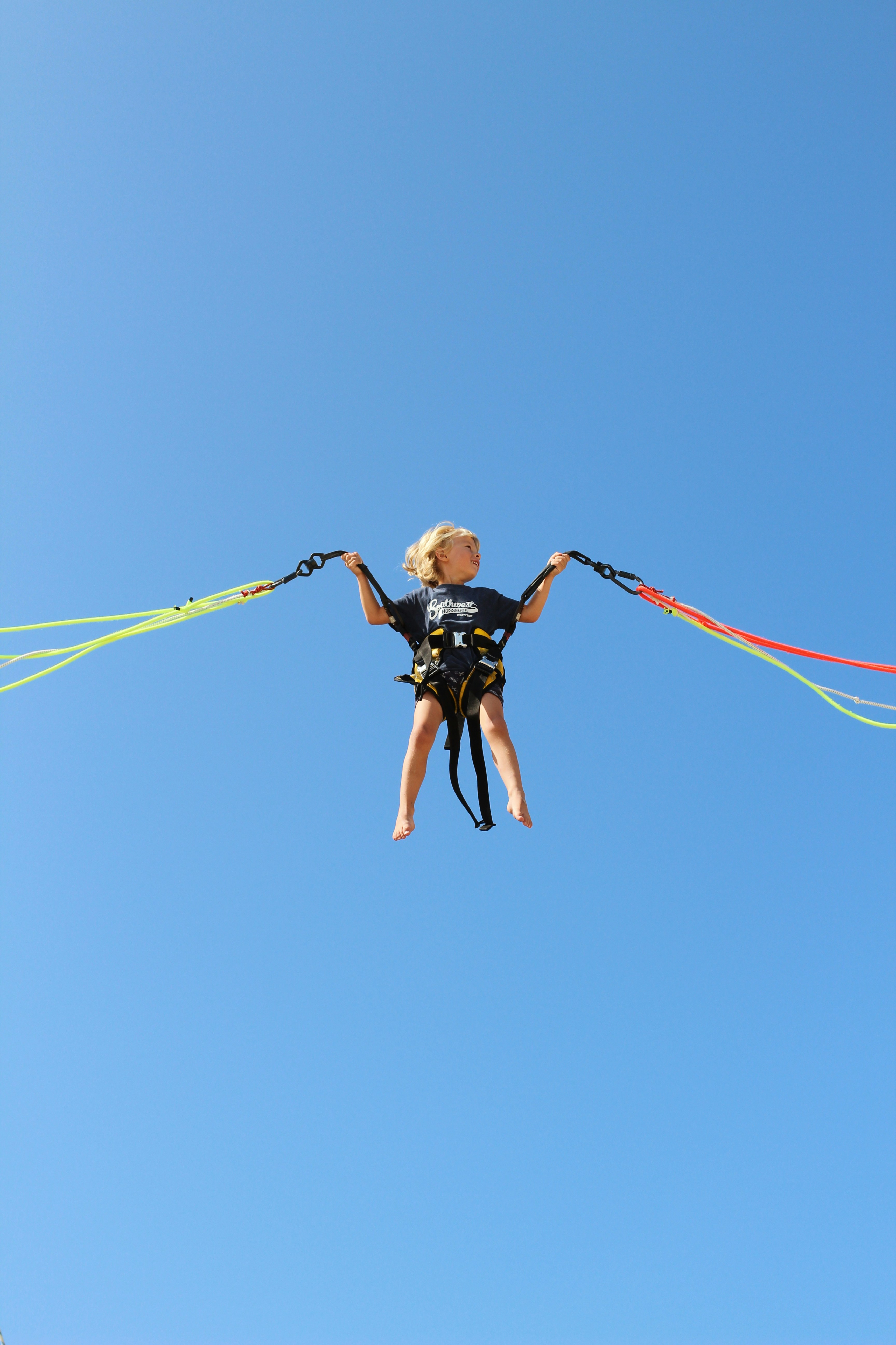 A man flying through the air while riding a kite photo – Free Biarritz ...