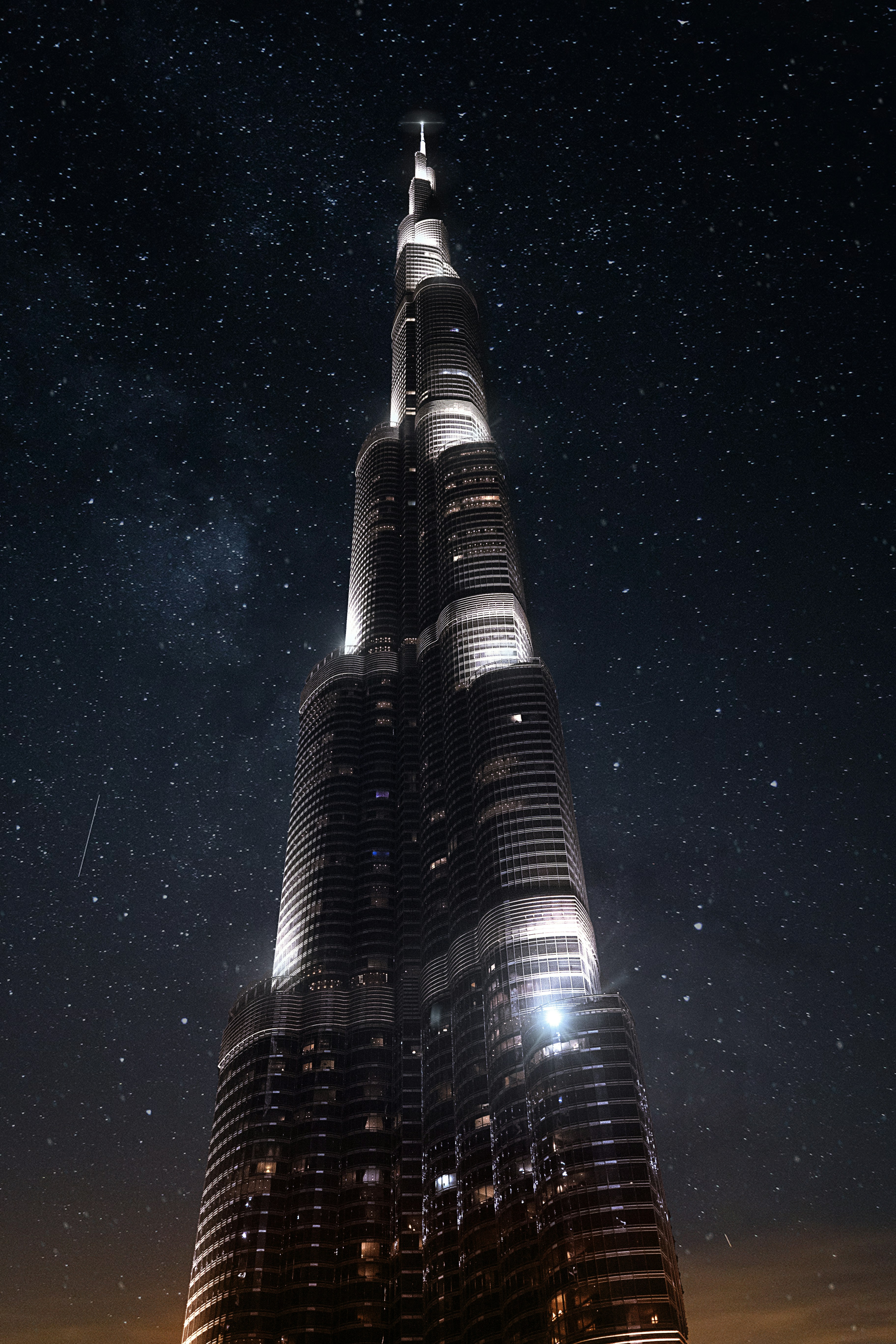 Burj Khalifa illuminated against a starry night sky, showcasing its architectural grandeur and vibrant lighting.