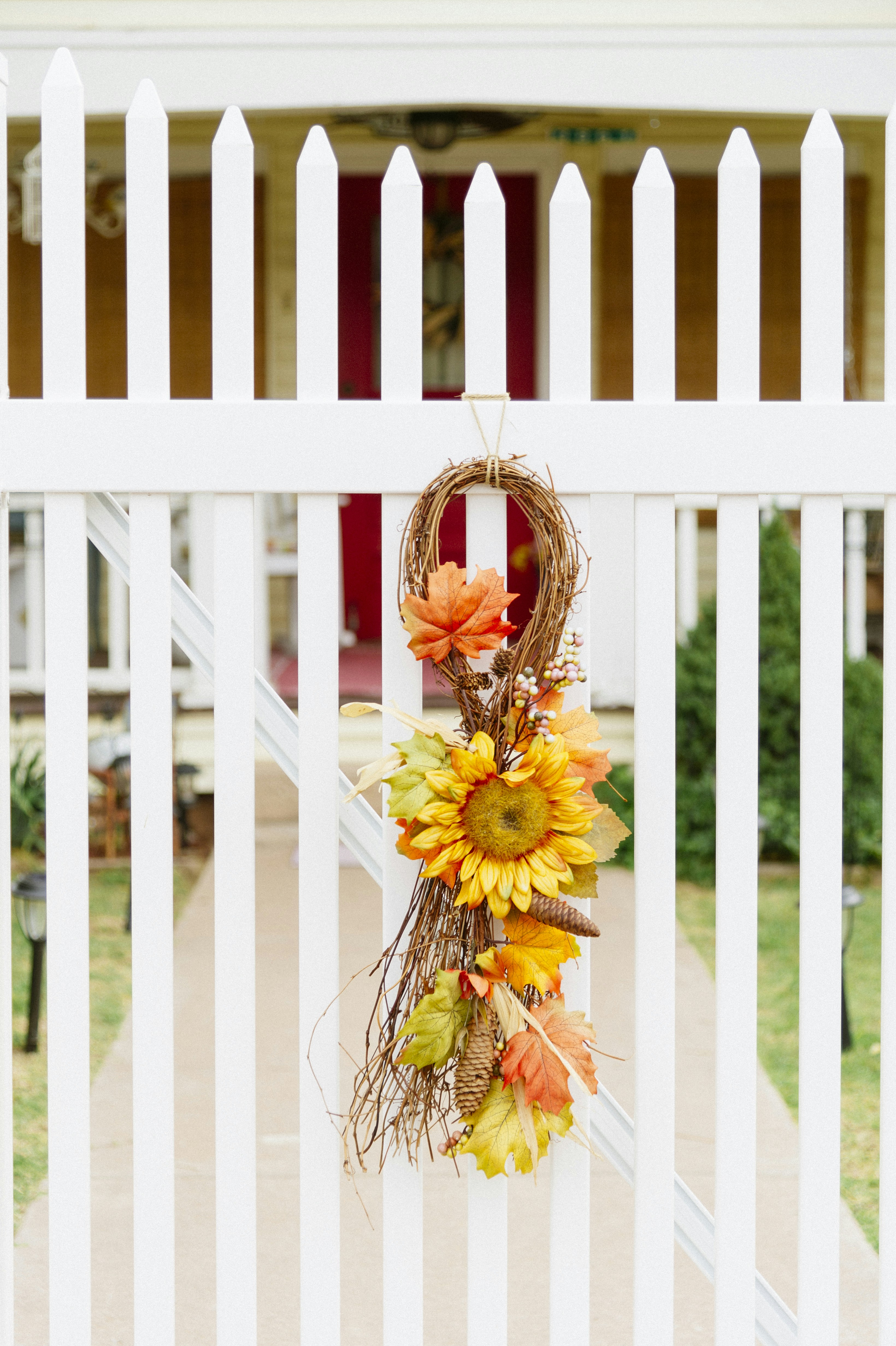 Autumn Wreath Adorning a White Gate