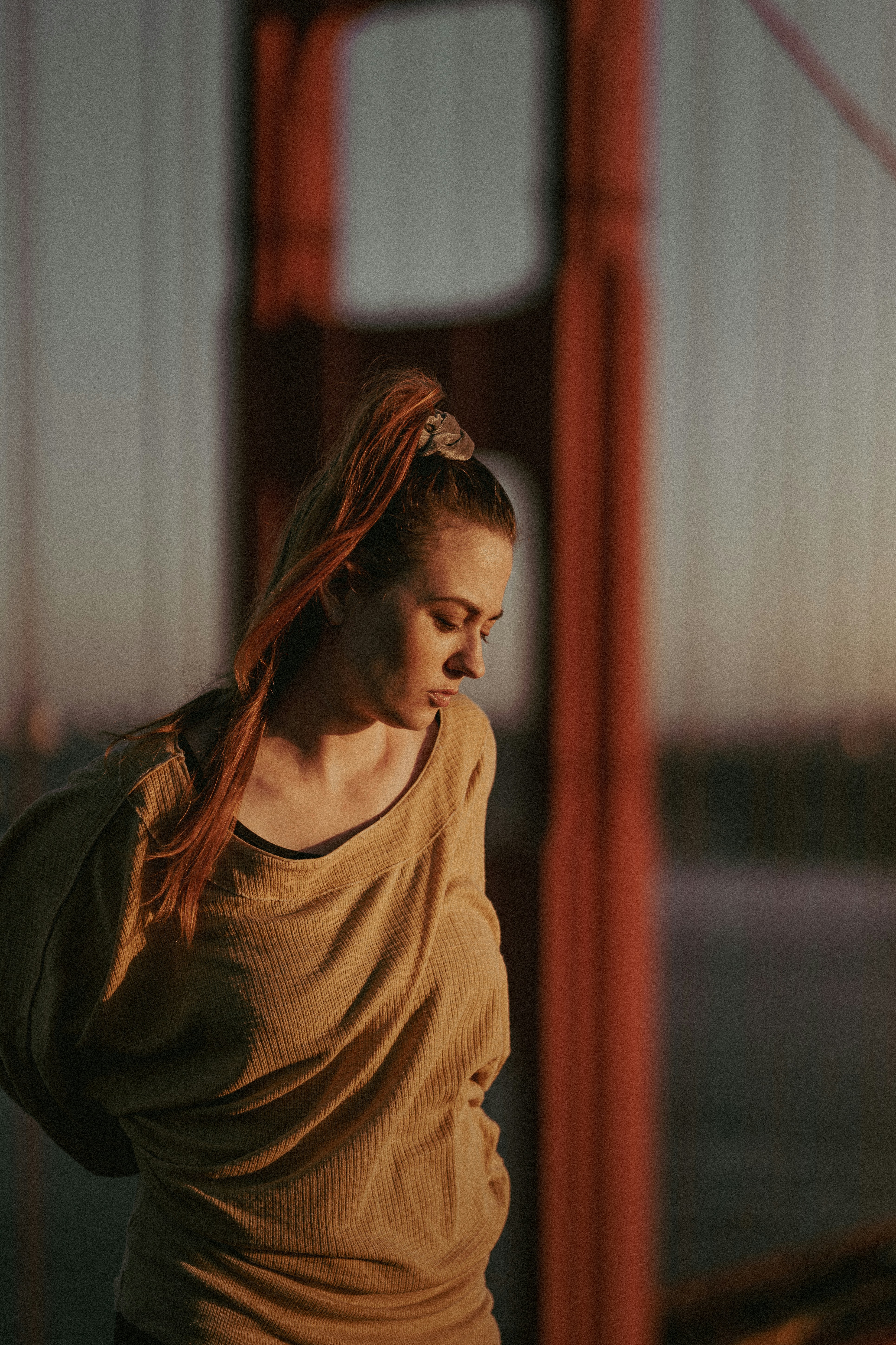 a woman standing in front of the golden gate bridge