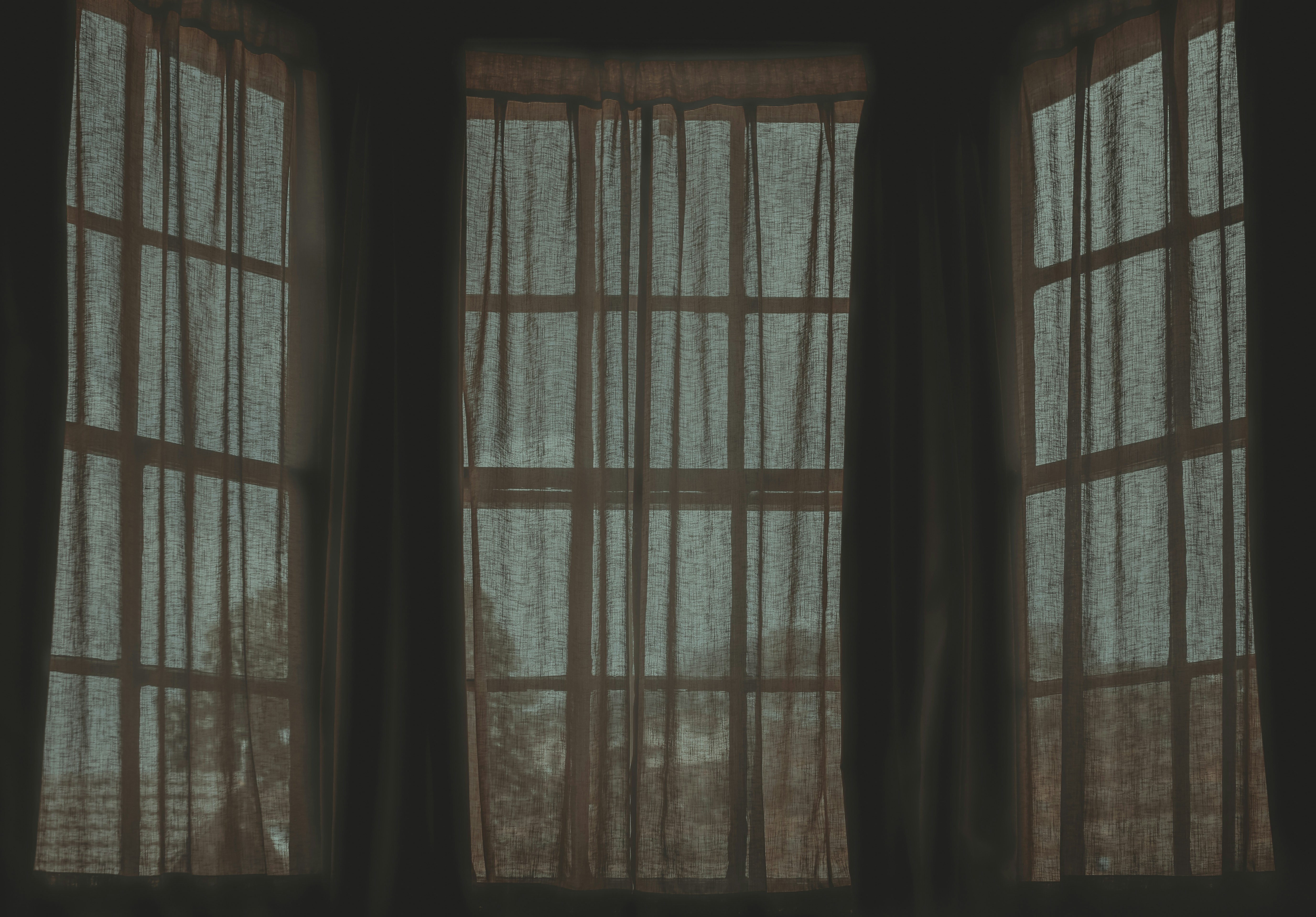 A dark room with two open windows with sheer curtains photo – Free Ooty ...