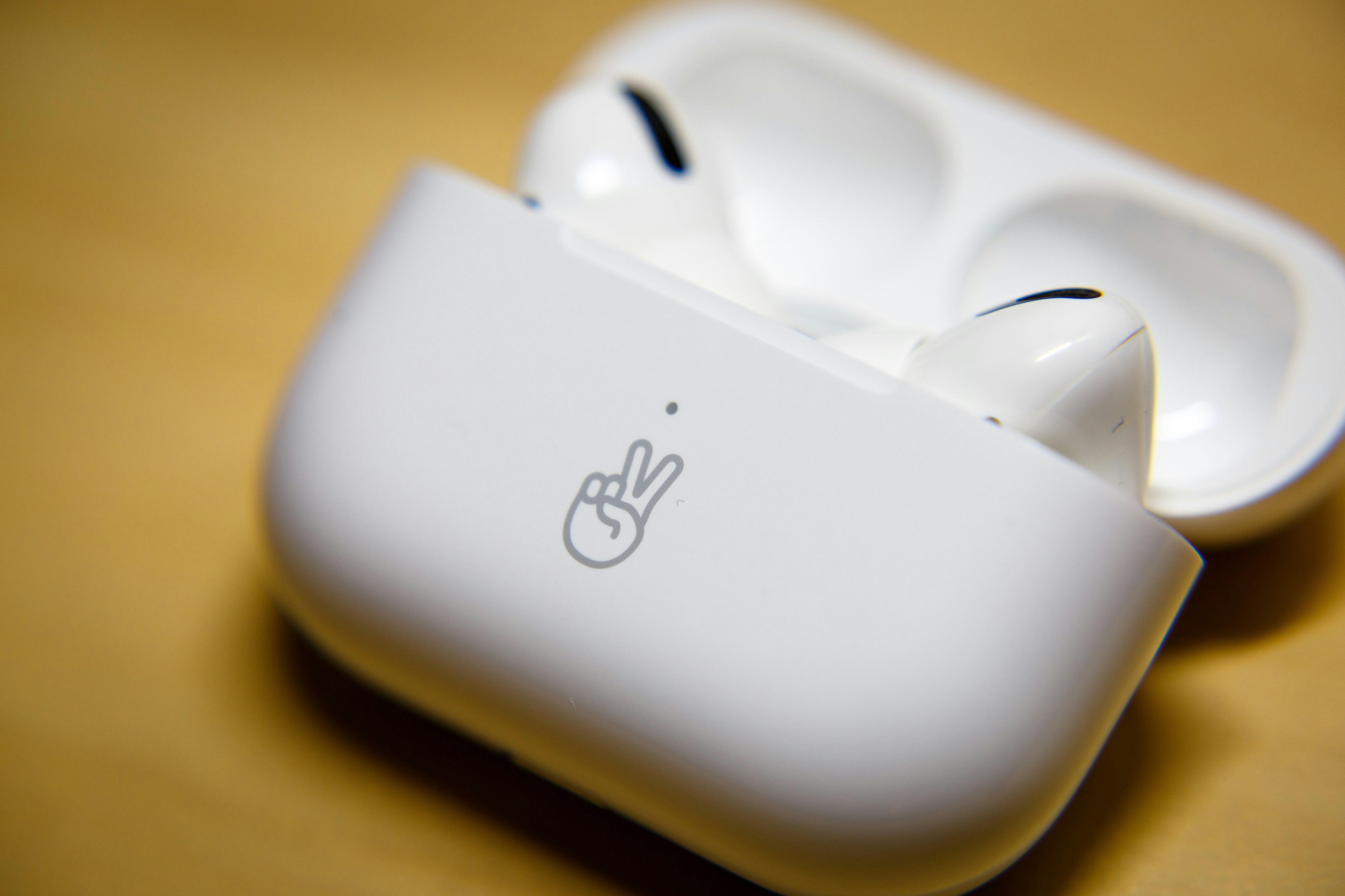 A pair of ear buds sitting on top of a table photo – Free Computer ...