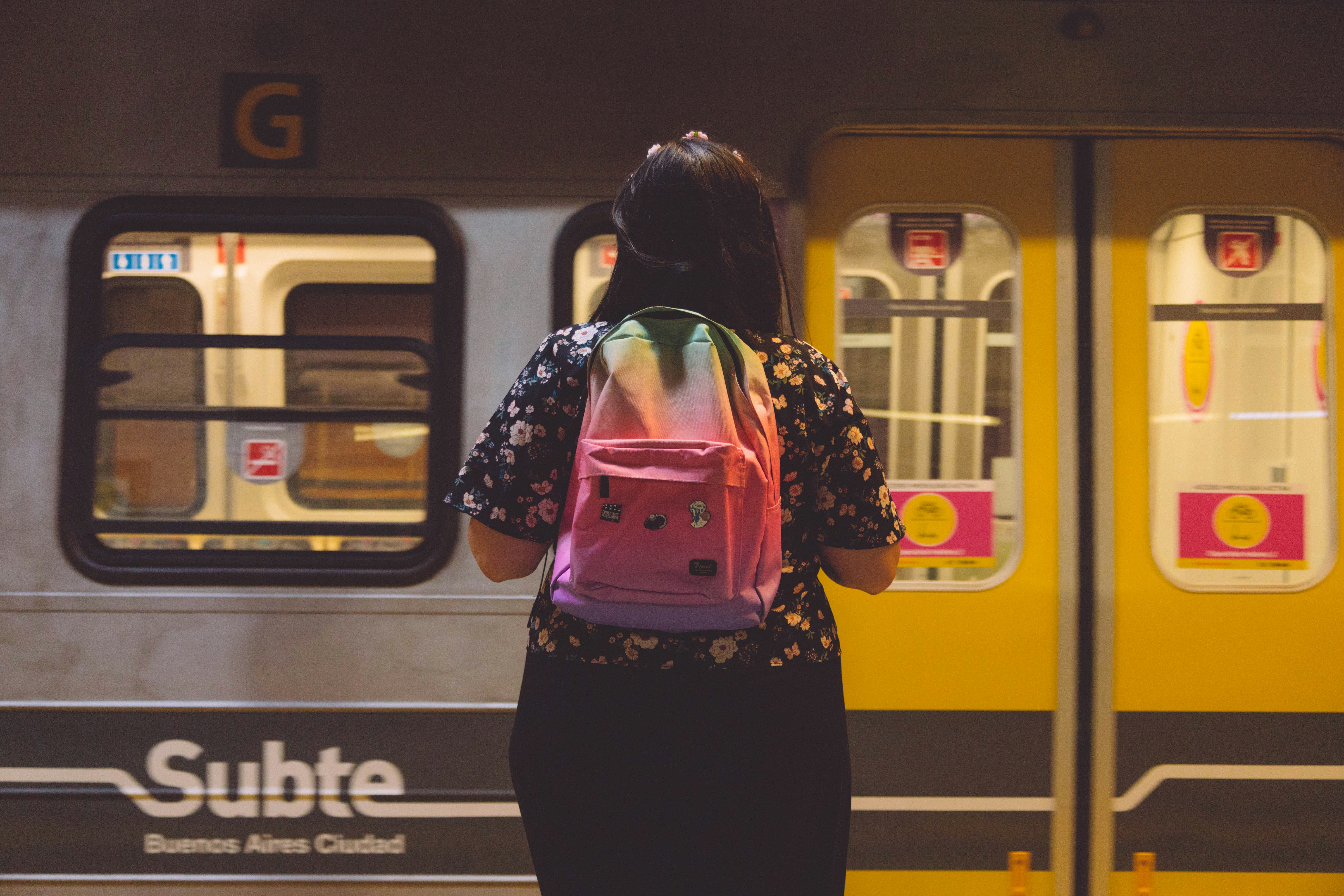 Pink Pack, Yellow Car: A Quiet Moment on the Subte