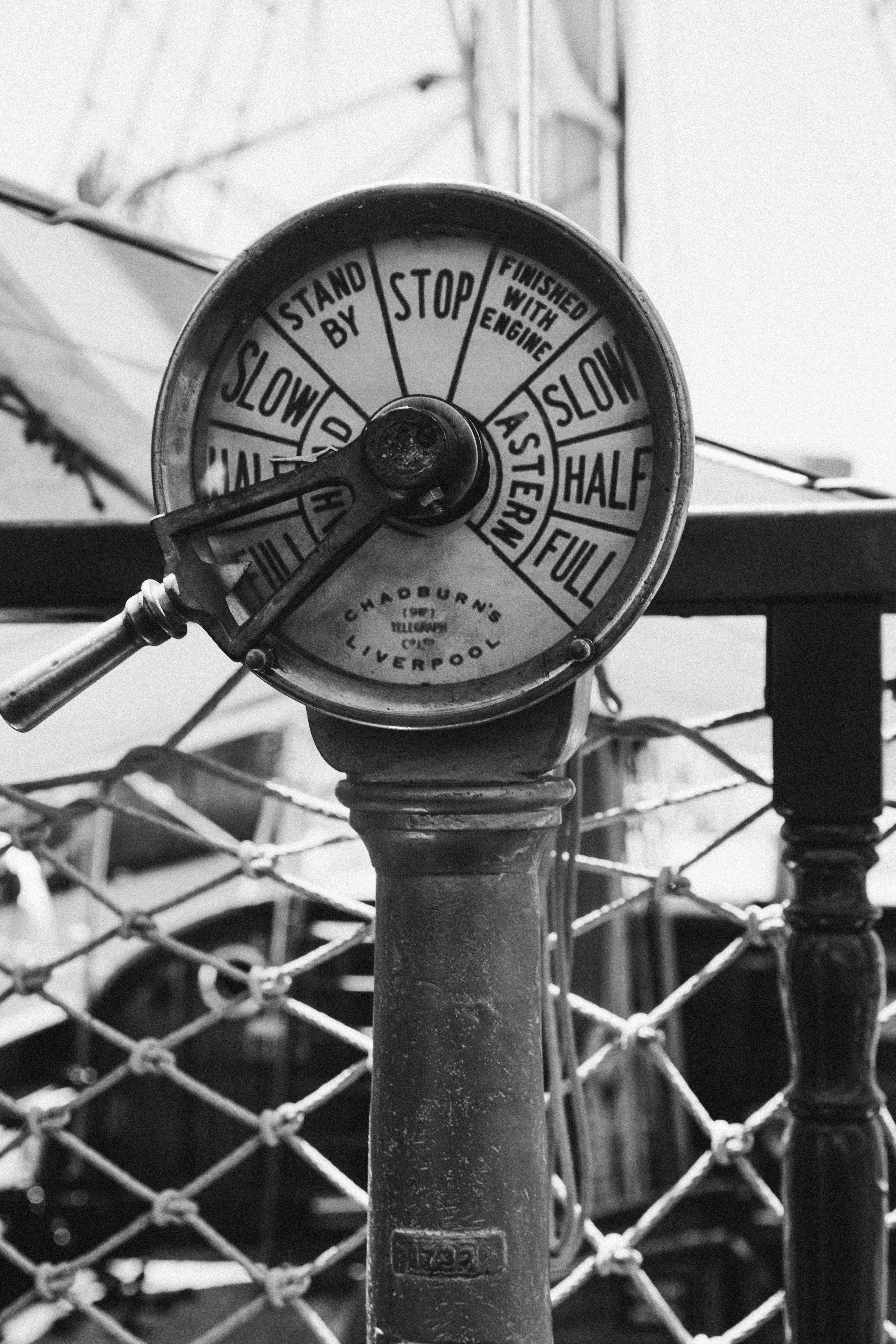 Circular Commander: A Weathered Ship Gauge in Monochrome