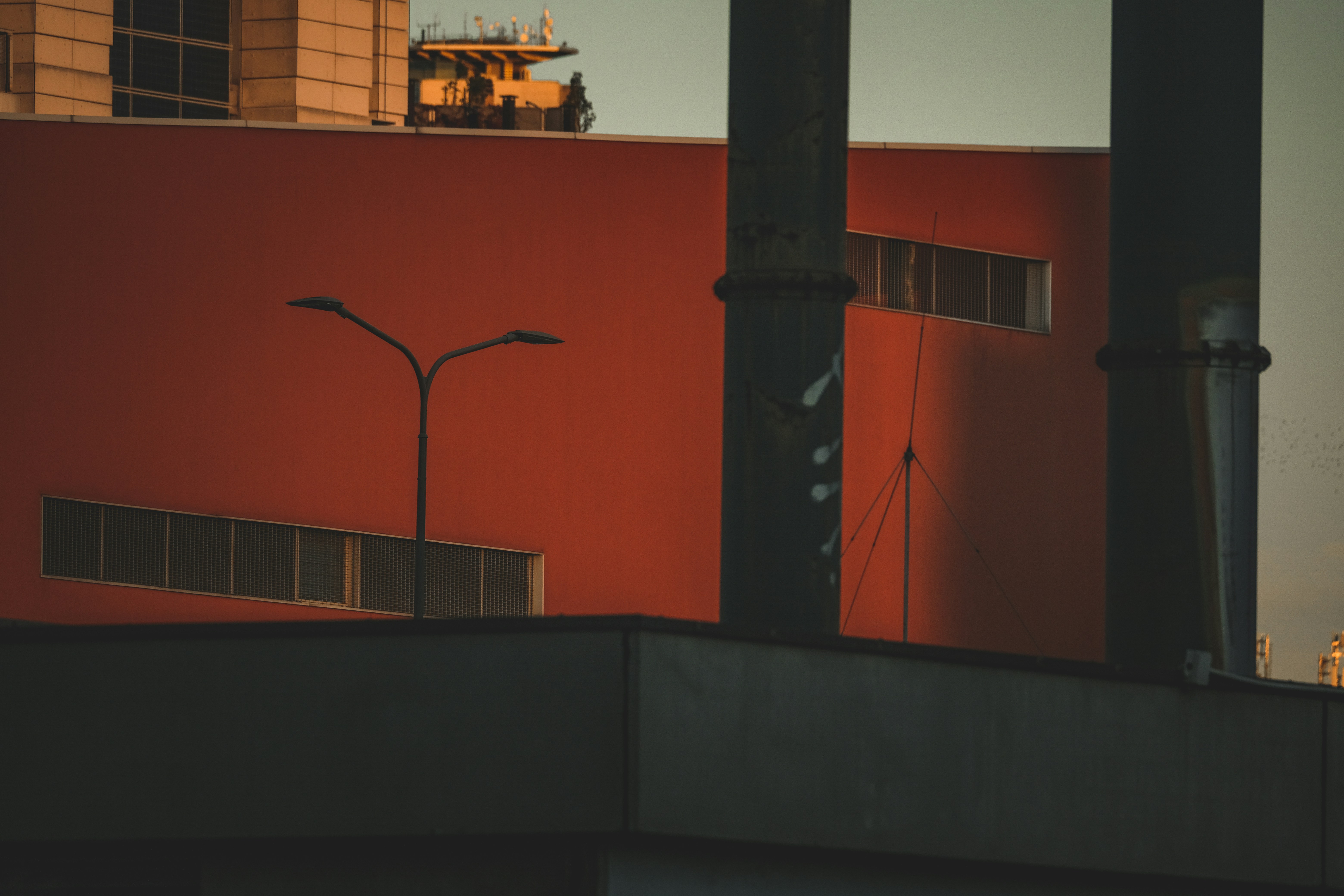 Abstract composition showcasing geometric shapes and contrasting colors in an urban environment. The interplay of light and shadow highlights architectural details.
