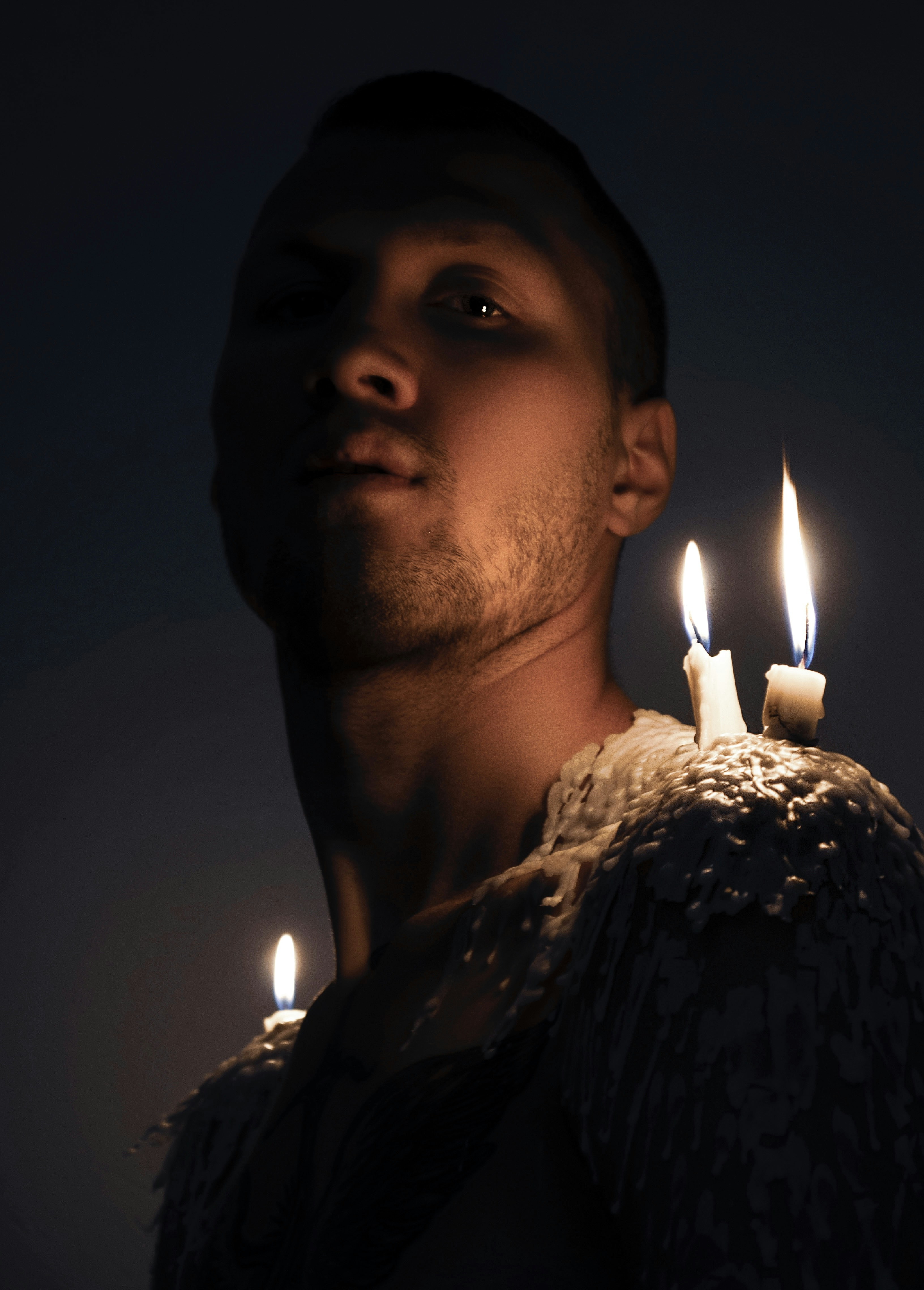 Candlelit Contemplation: A Quiet Portrait in Shadow