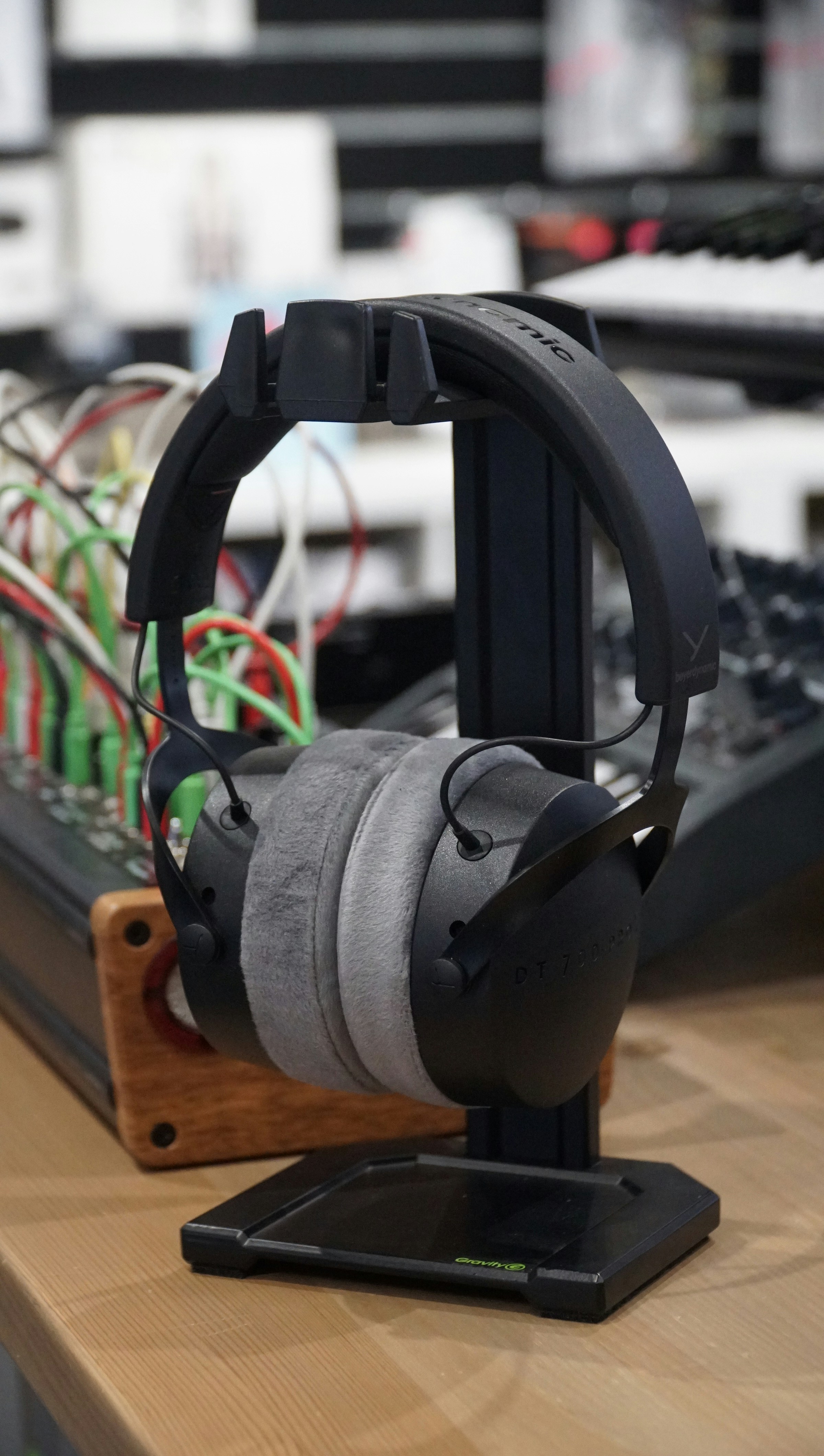 Headphones on a Stand Amid a Cable Maze in a Busy Studio