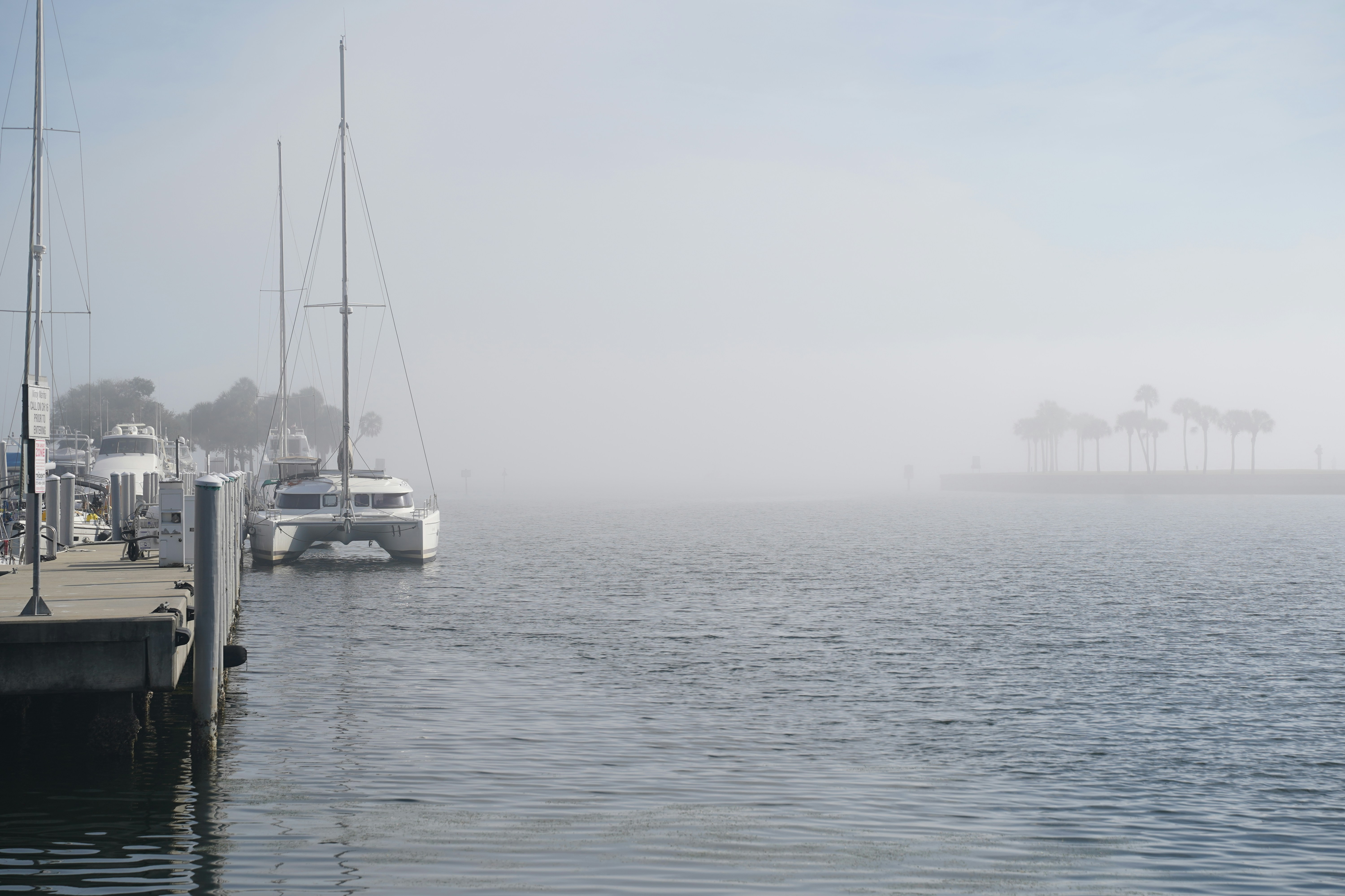 Fog-Quiet Marina: Boats Rest at the Edge of a Puffy Mist