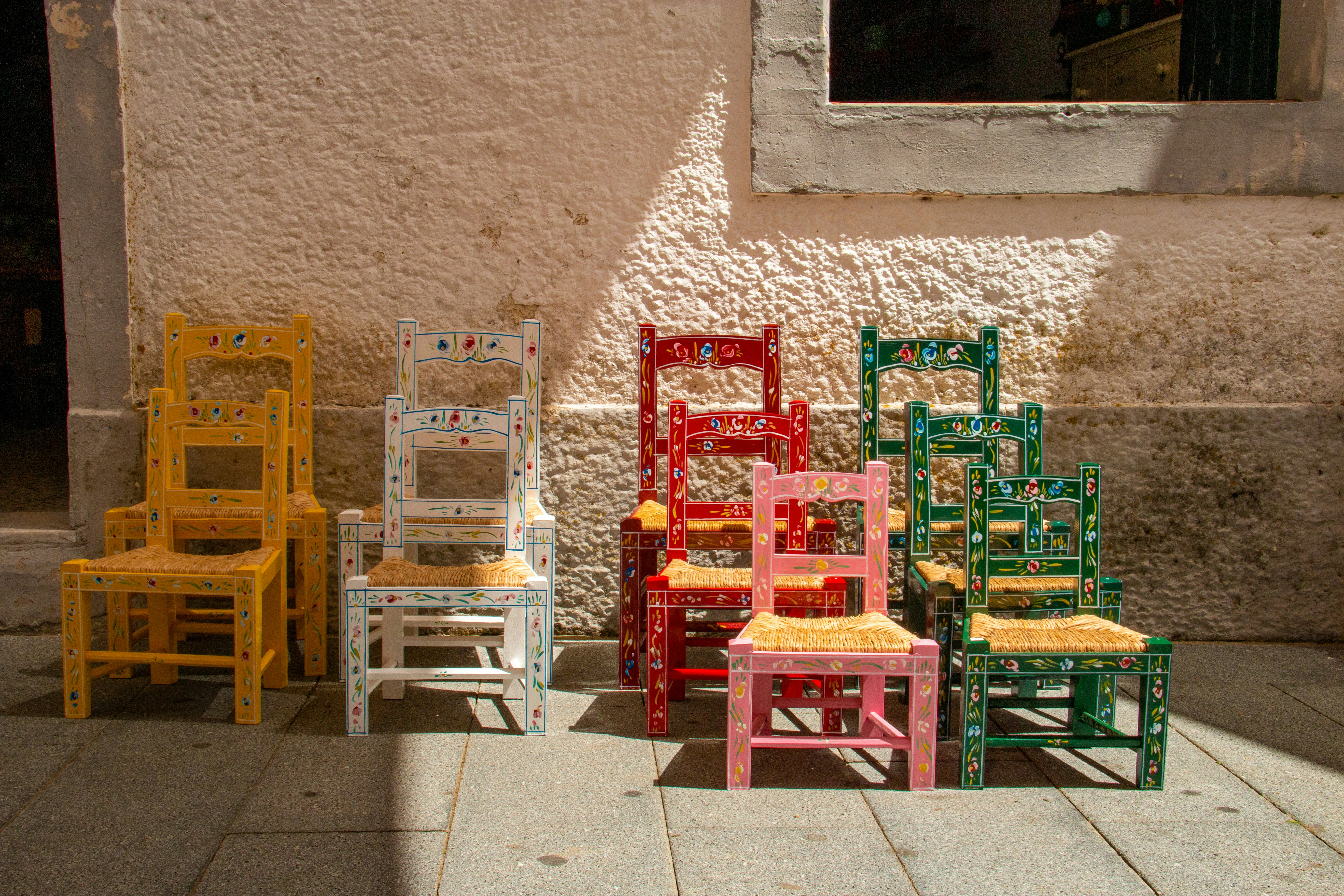 Colorful Chairs in Sunlit Row Cast by Building Shade