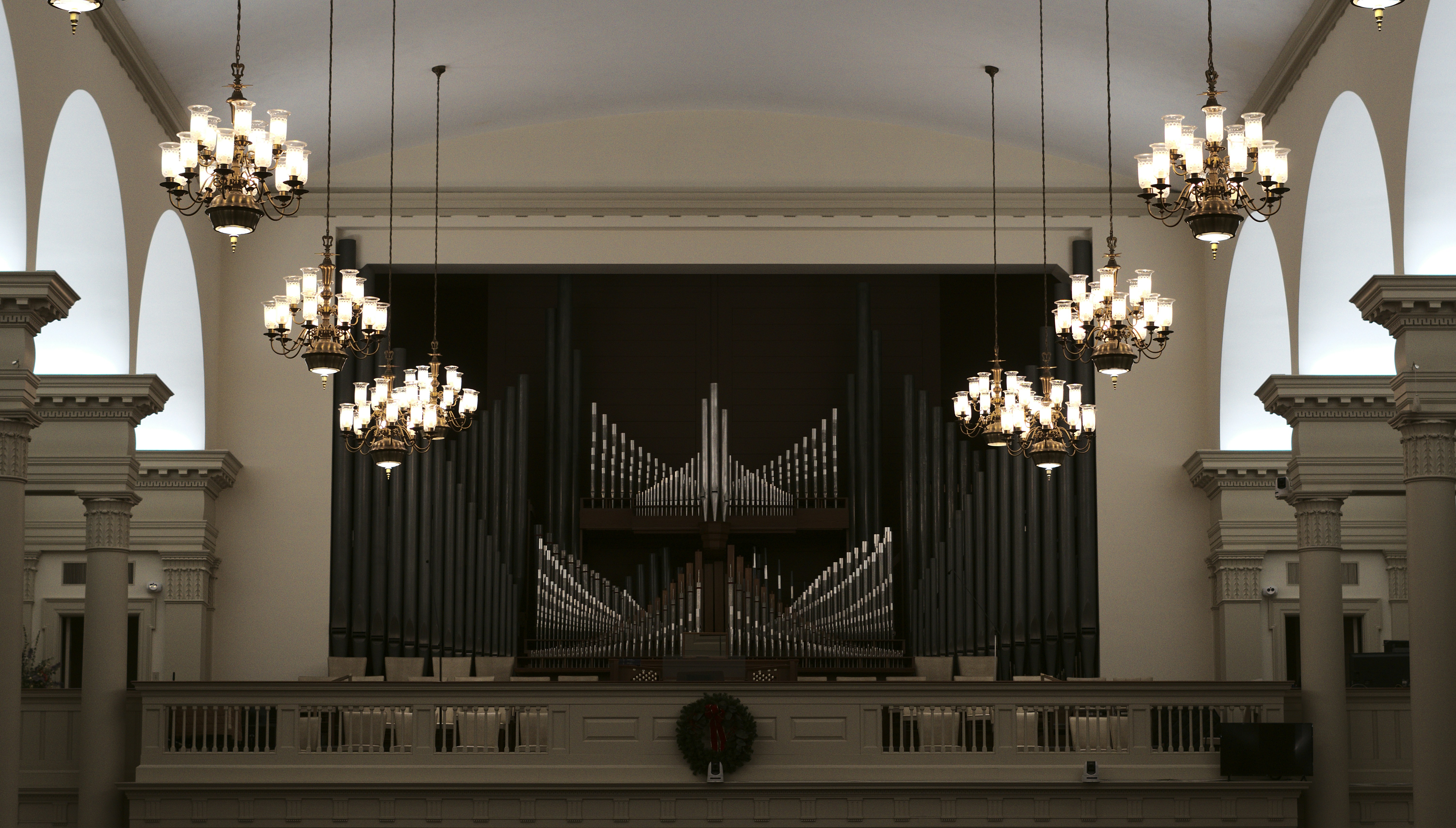 a church with a pipe organ and chandelier