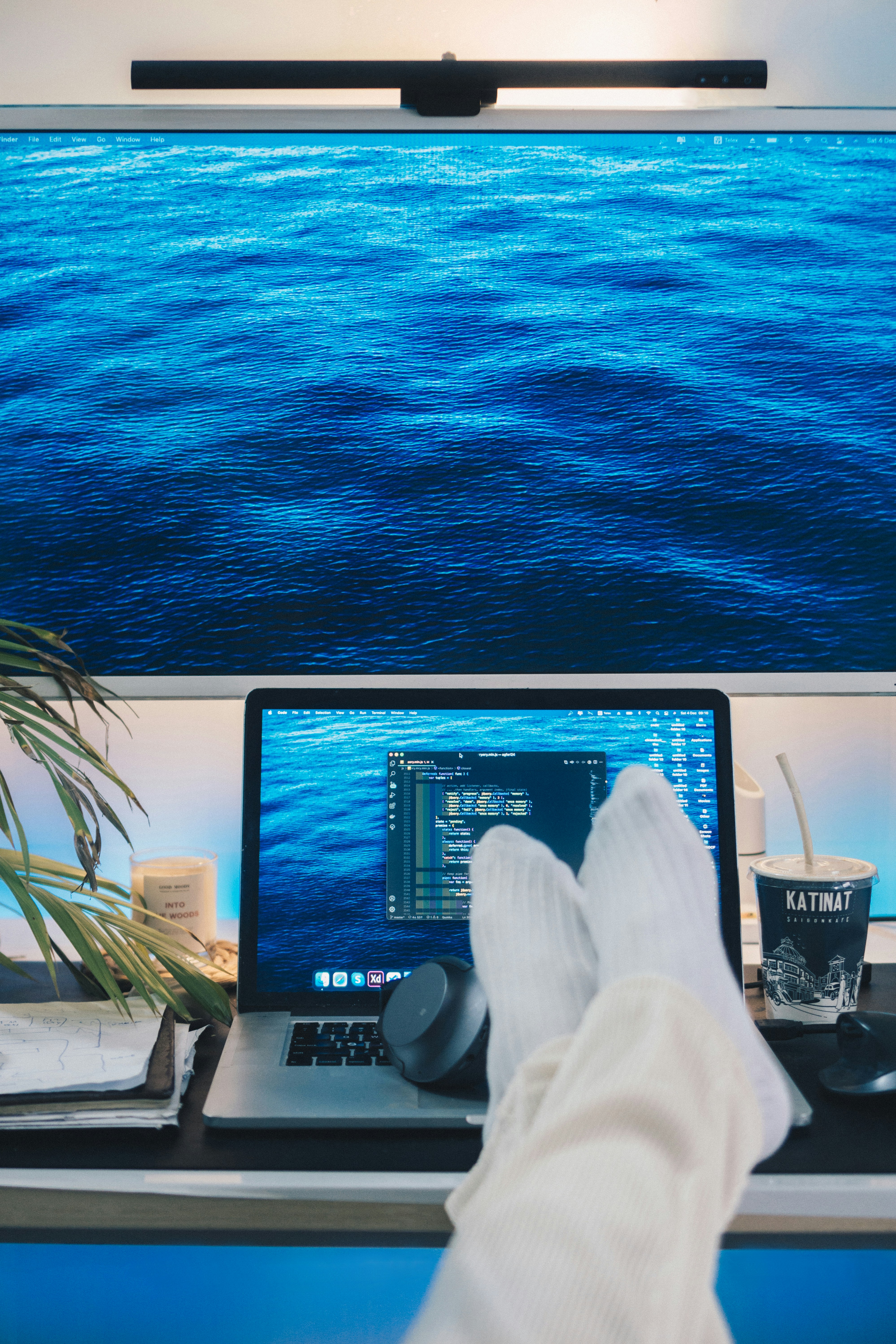 Cozy Tech Desk: Feet Propped Up as code Burns Bright on the Screen
