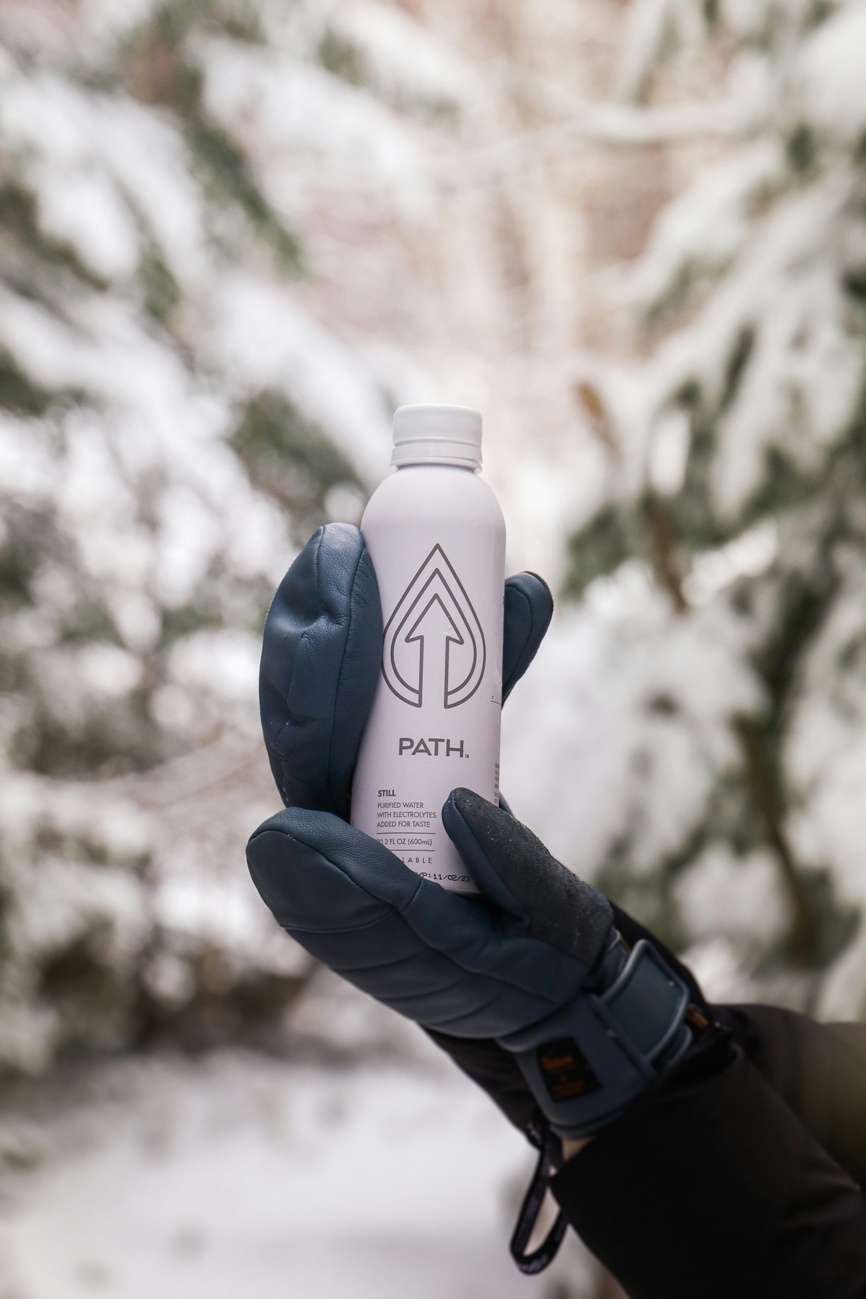 Path. Bottle in a Snowy Stillness: A Gloved Grip in the Forest