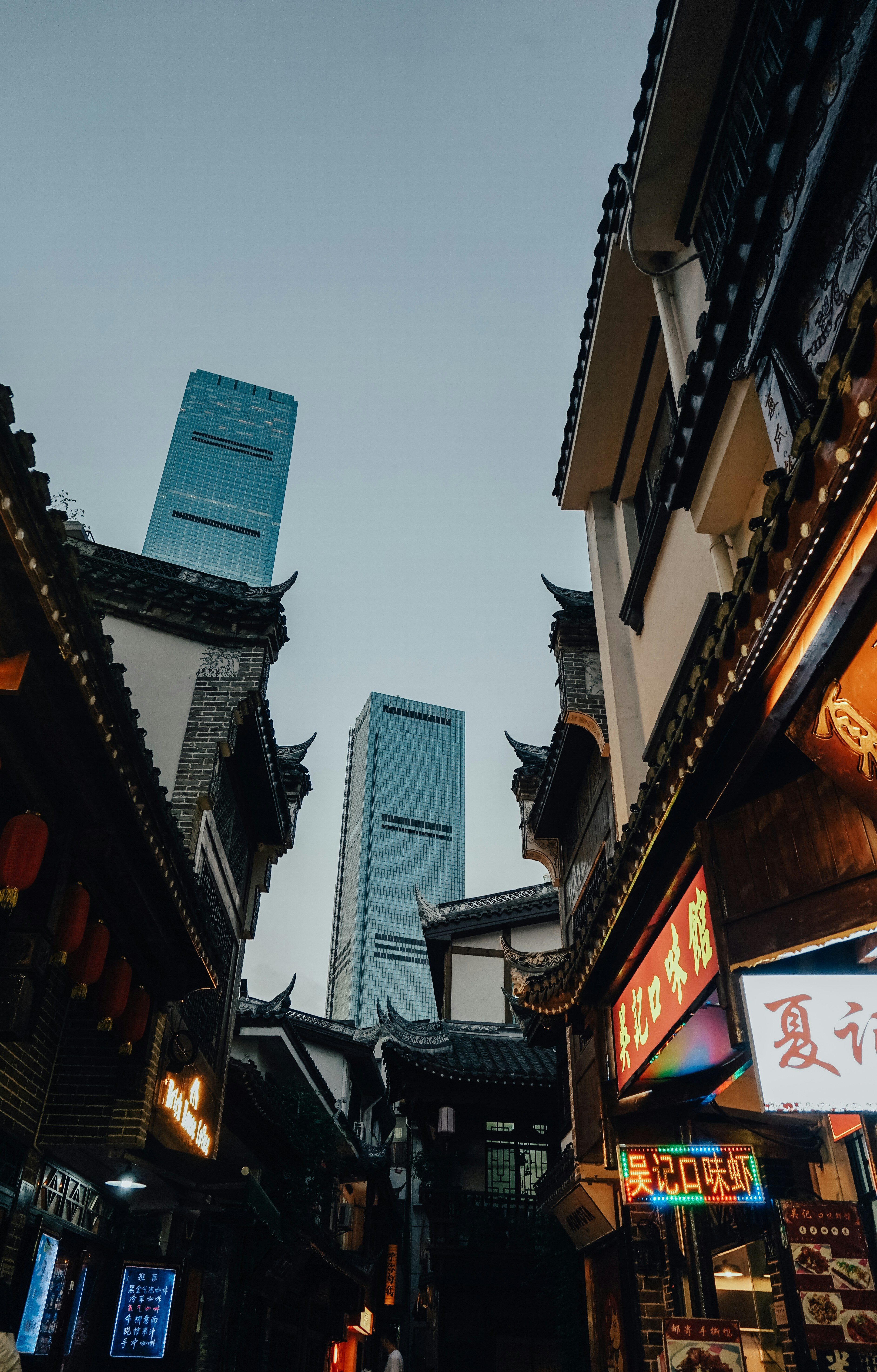 Skyward Alley: Modern Towers Framing a Traditional Street