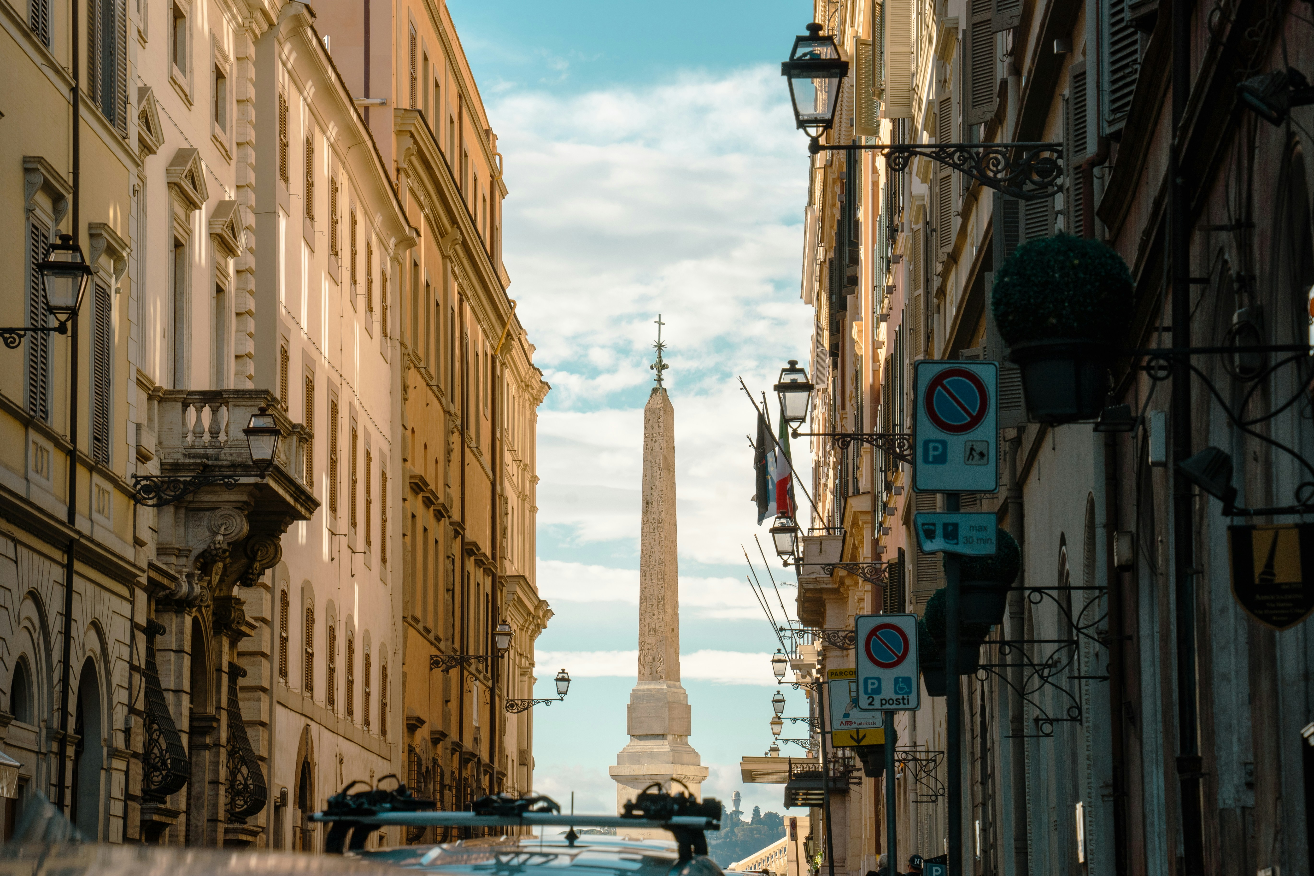 A city street with a tall obelisk in the background photo – Free ...