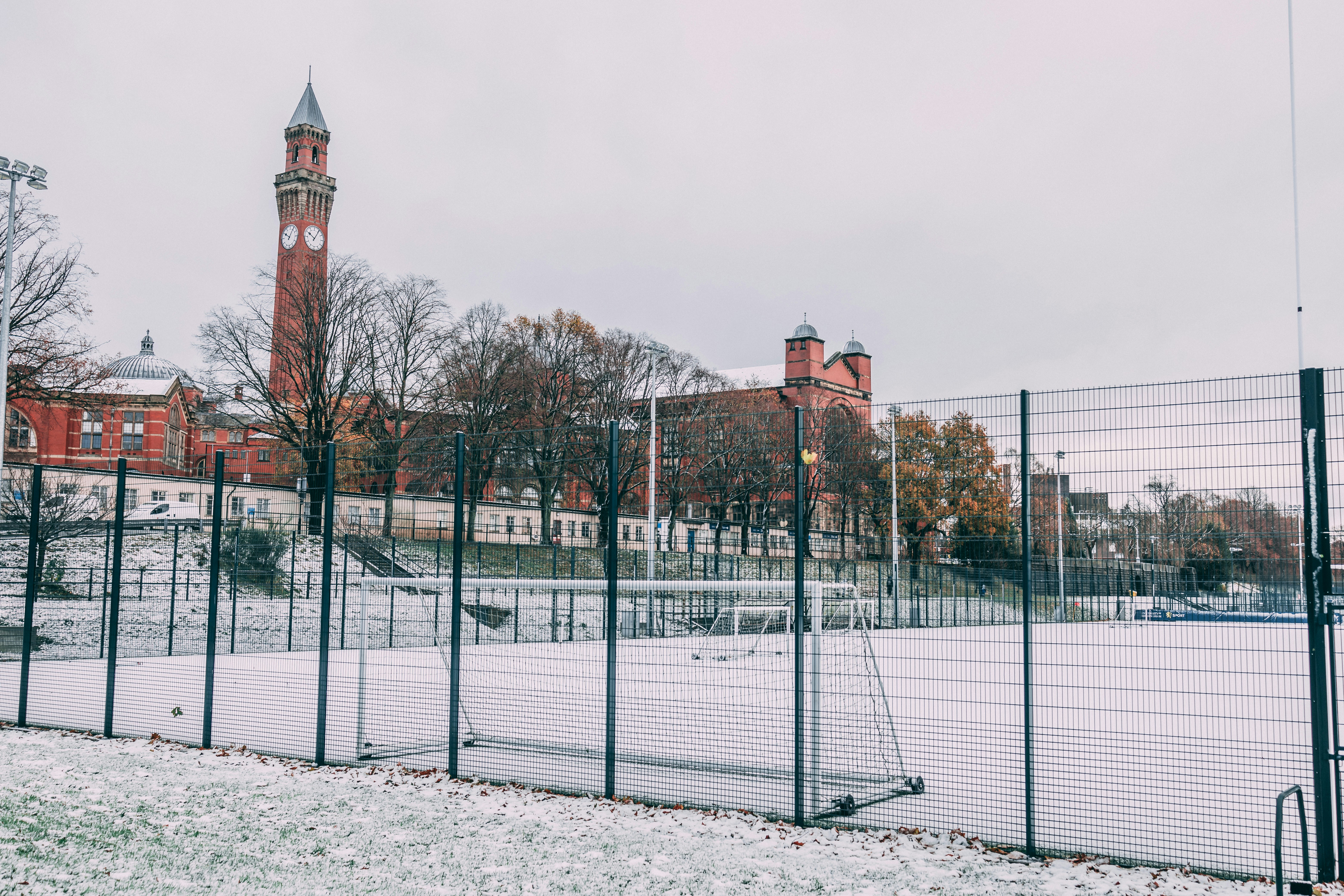 Clock Tower Over Snow-Fenced Campus