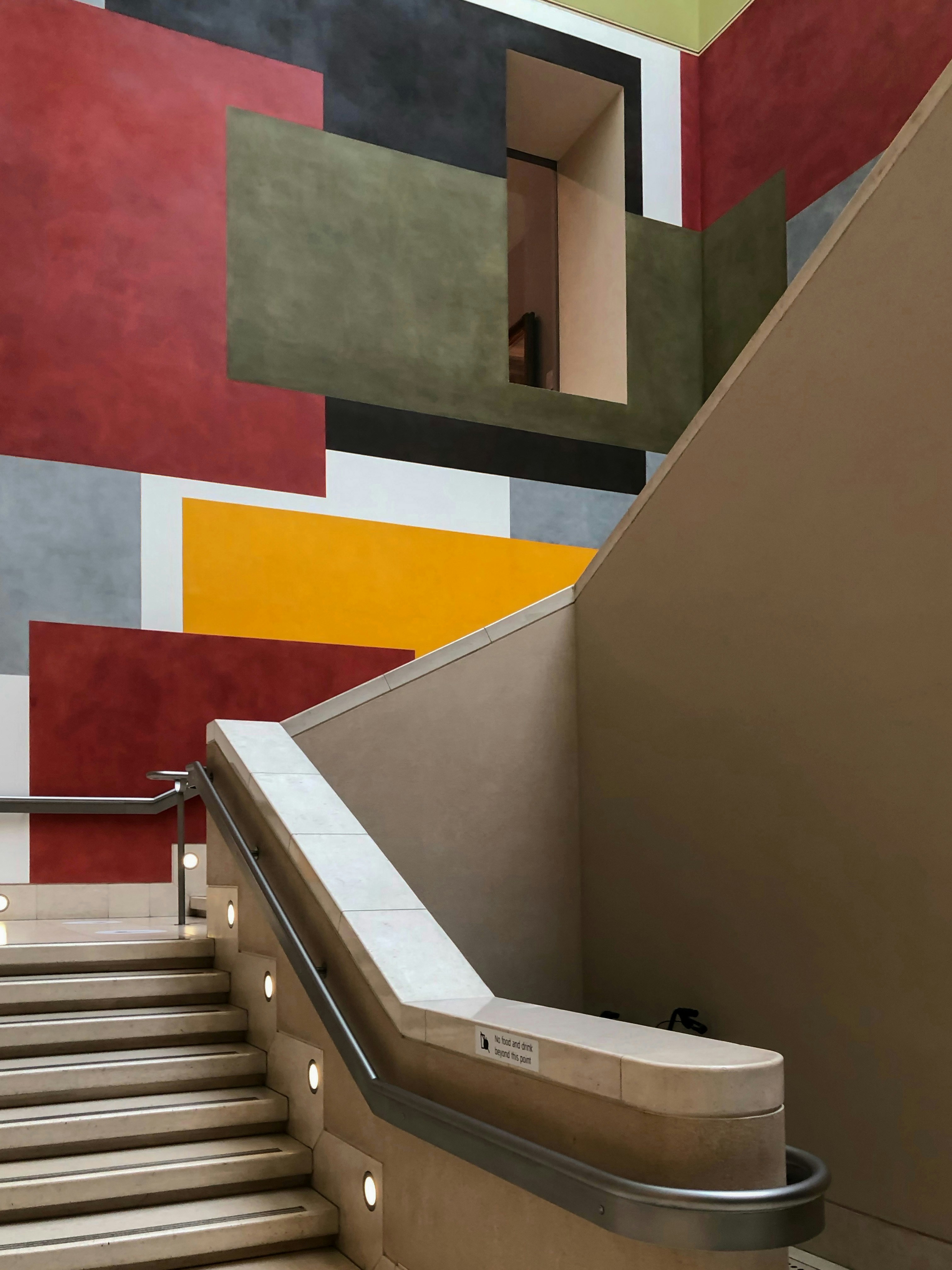 A staircase with a bunch of different colored tiles on the wall photo ...